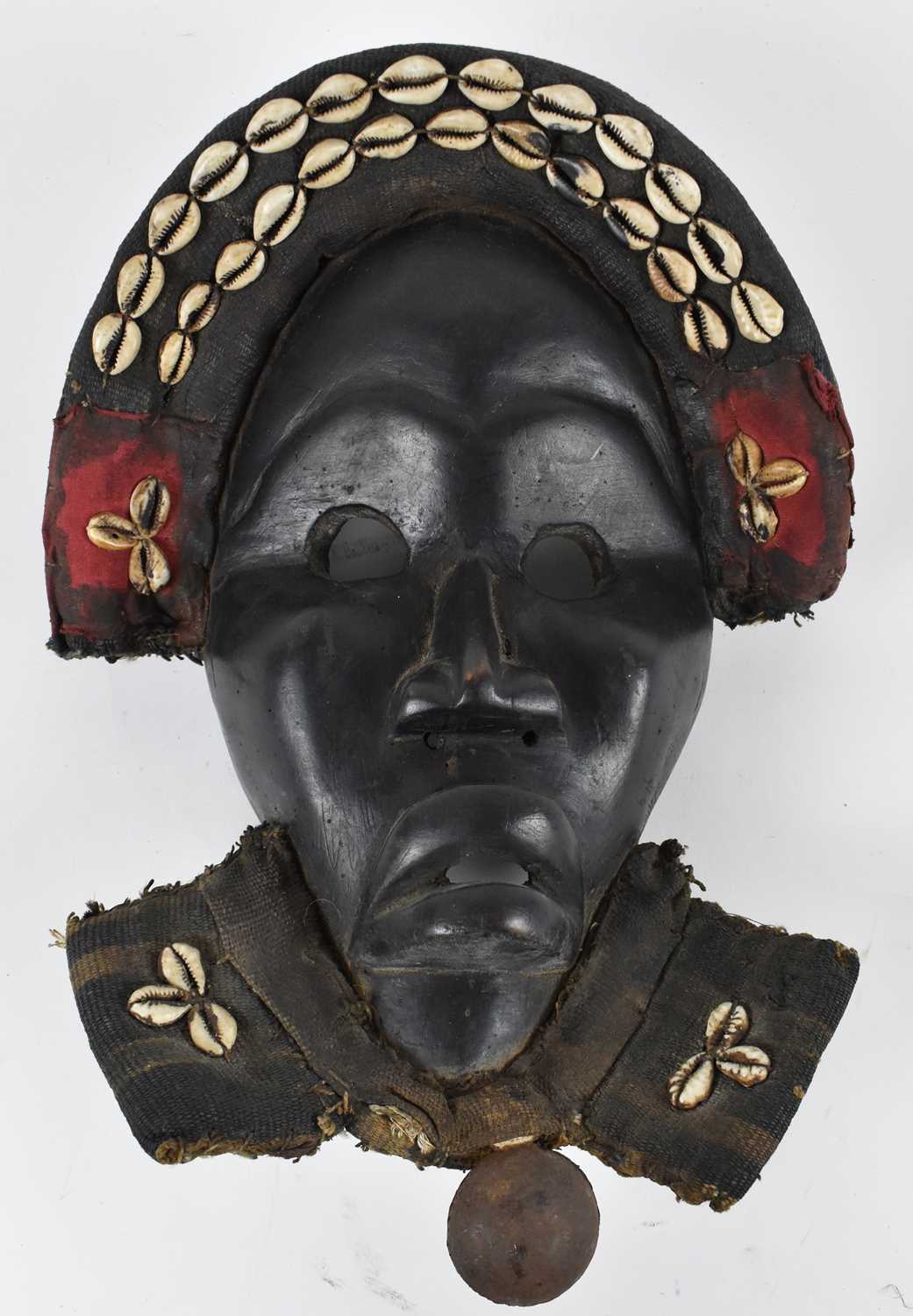 Lot 459 - TRIBAL ART; a carved Dan mask adorned with