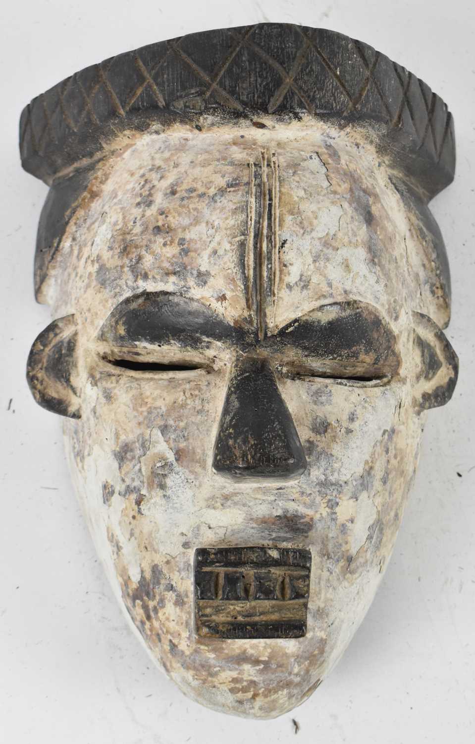 Lot 453 - TRIBAL ART; a West African carved wooden