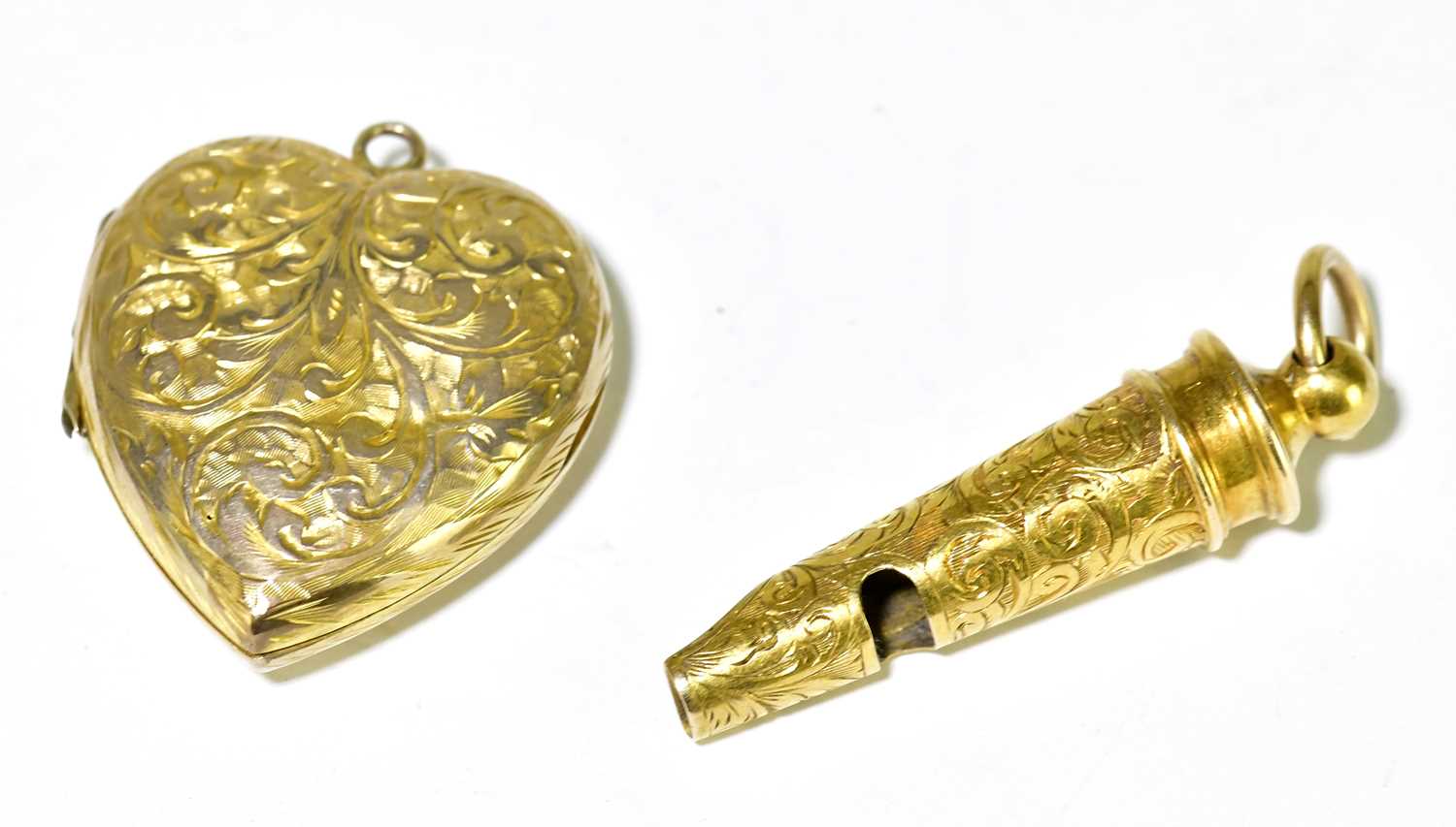 Lot 356 - A yellow metal engraved whistle with ring