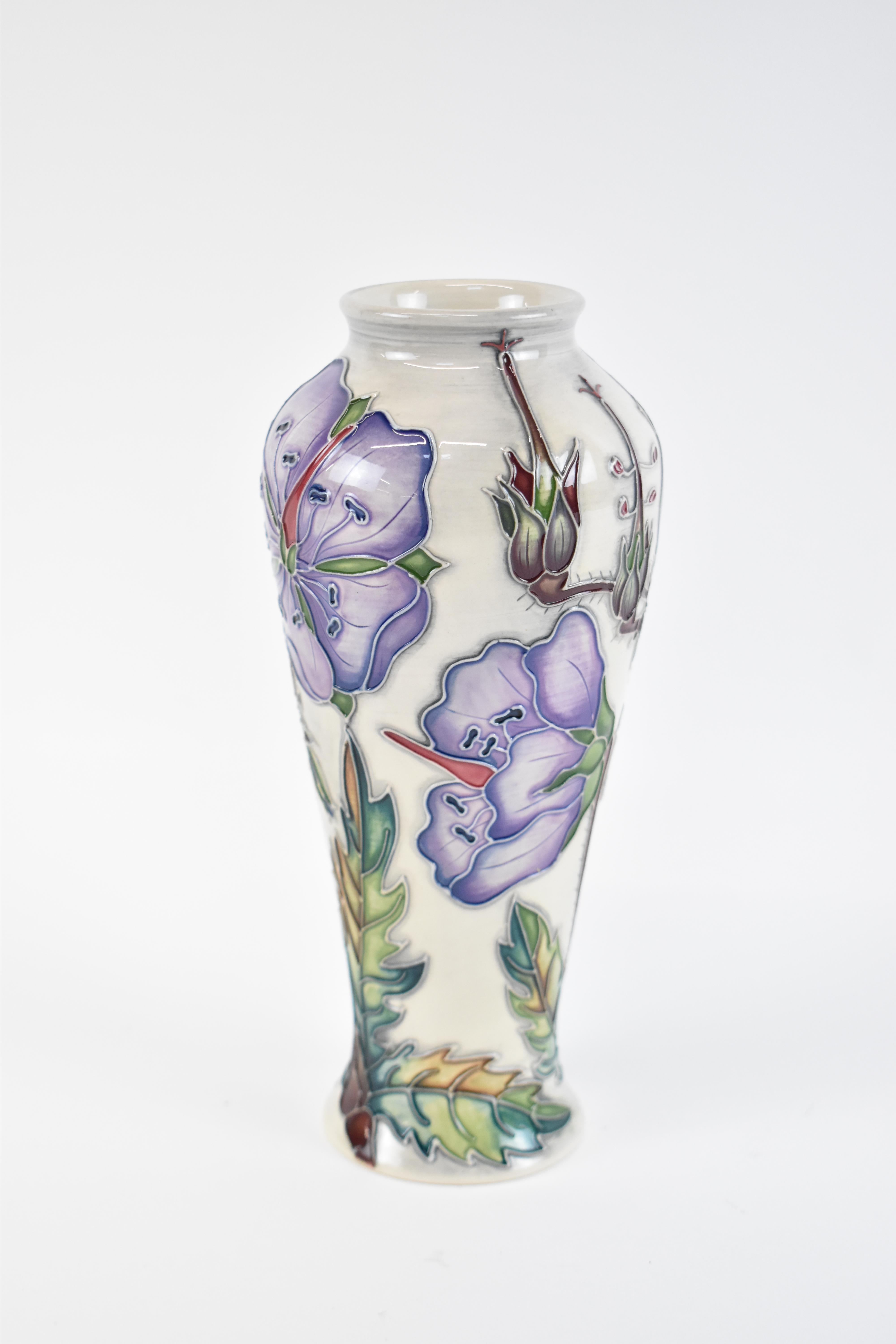 Lot 429 - MOORCRAFT; a white ground vase decorated in