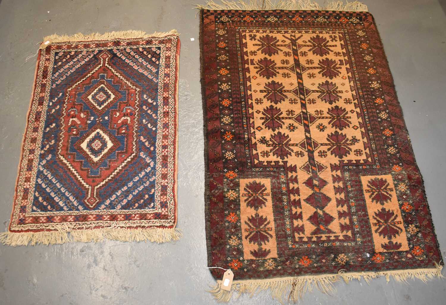 Lot 95 - Two hand knotted red ground rugs, 140 x 76cm