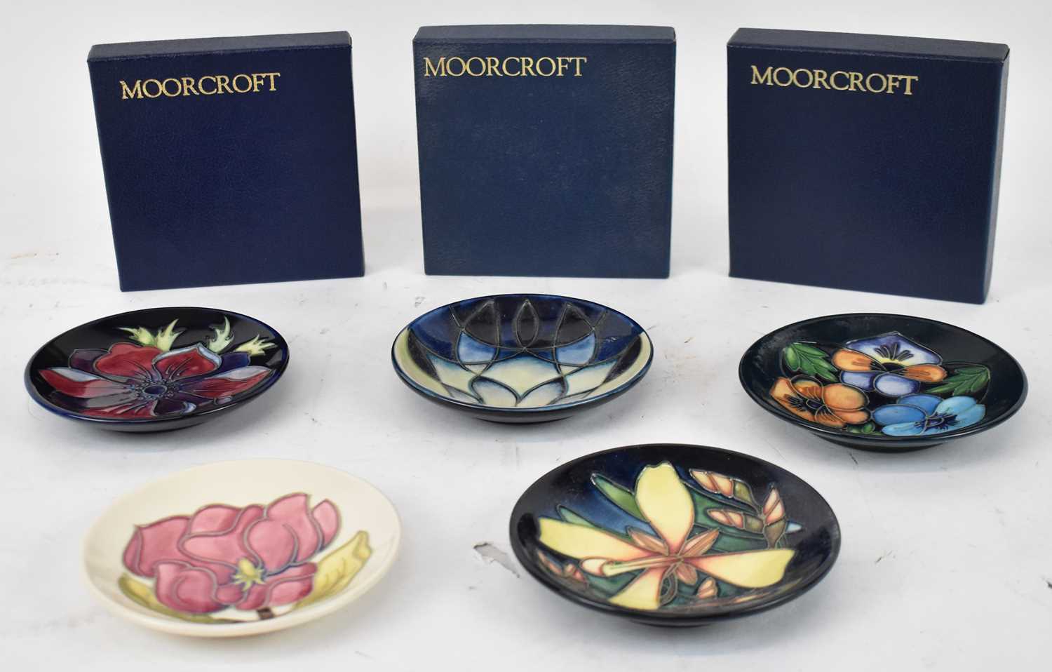 Lot 443 - MOORCROFT; a group of five pin dishes, some