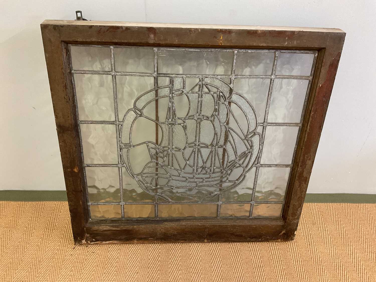 Lot 369 - A leaded glass window decorated with a