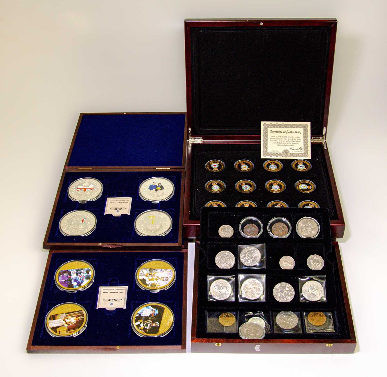 Lot 44 - Four wooden coin cases containing various