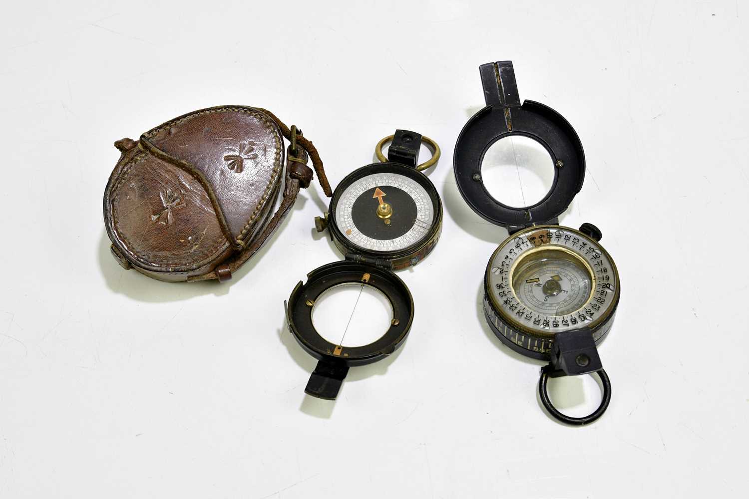 Lot 437 - Two military compasses, one in leather case.