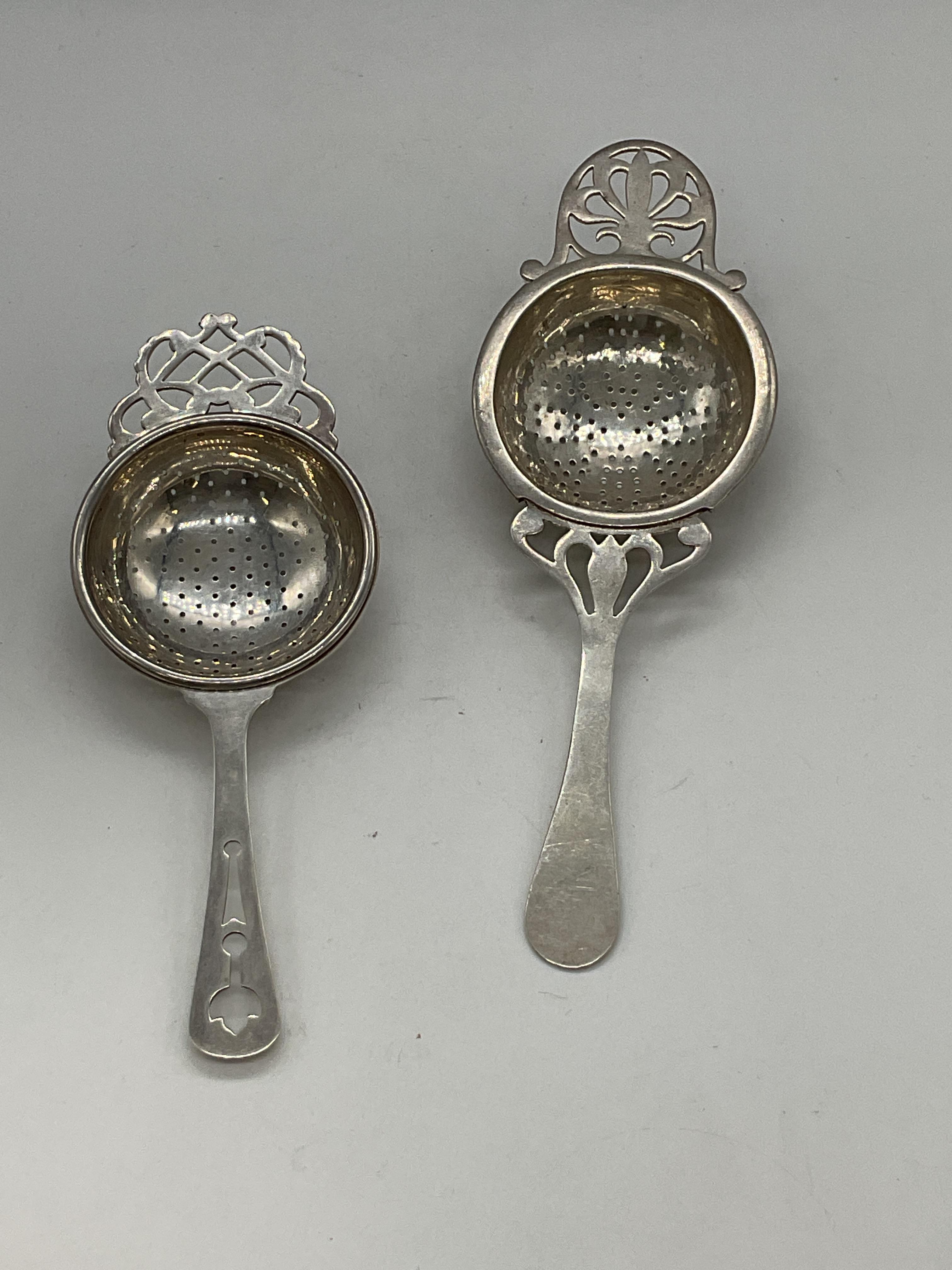 Lot 1095 - Two hallmarked silver tea strainers with