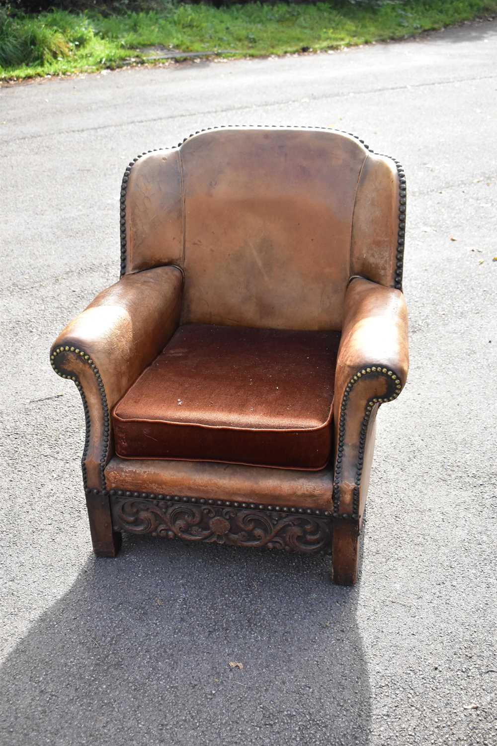 Lot 2500 - A 1920s studded leather wing back smoking