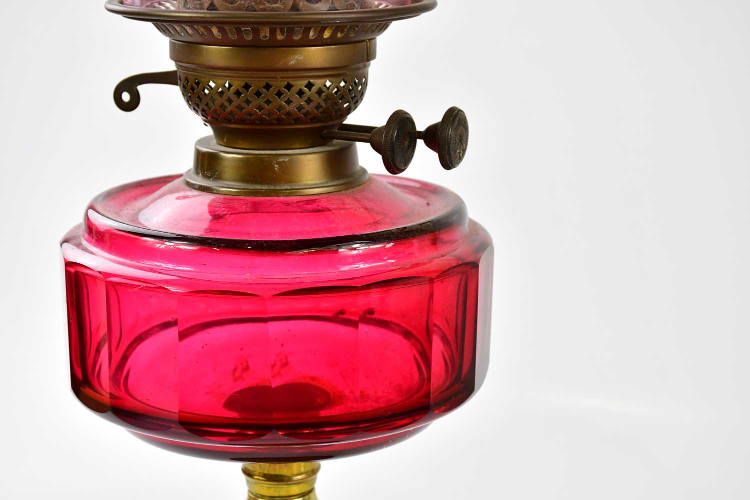 Lot 1582 - A Victorian oil lamp, the fluted cranberry