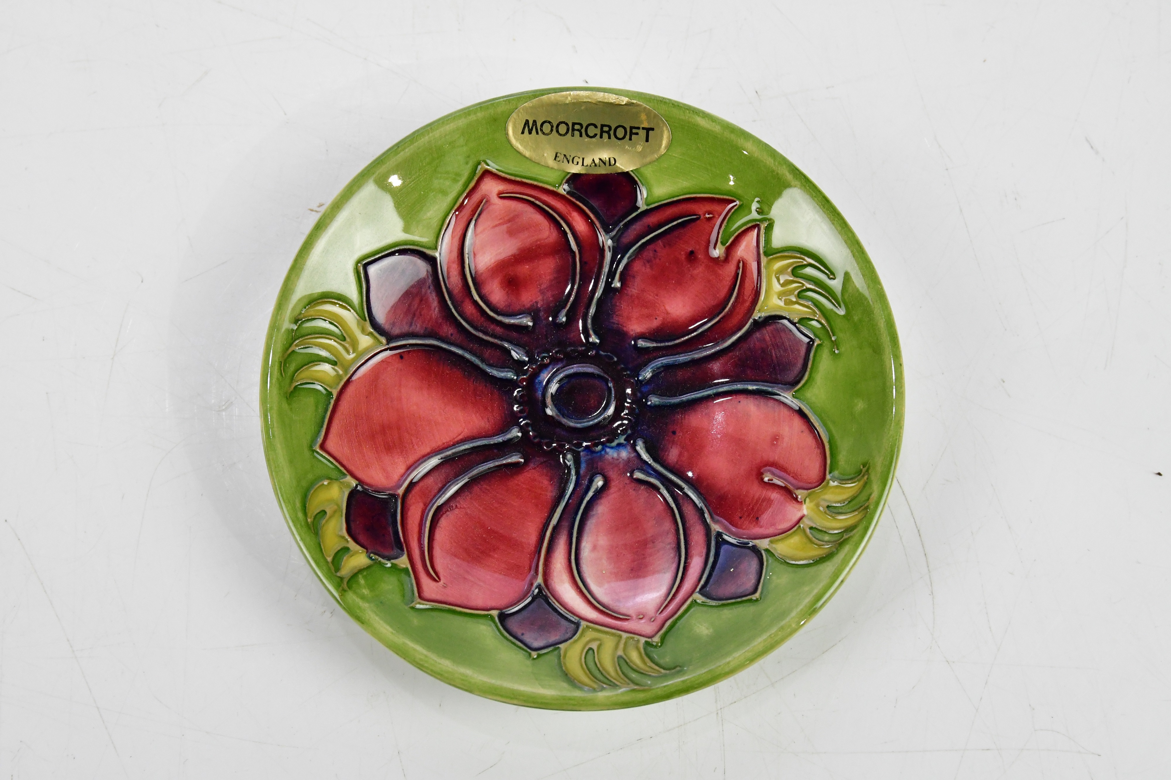 Lot 112 - MOORCROFT; four ceramic pin dishes including