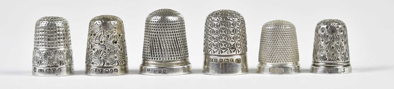 Lot 1088 - Six hallmarked silver thimbles including a