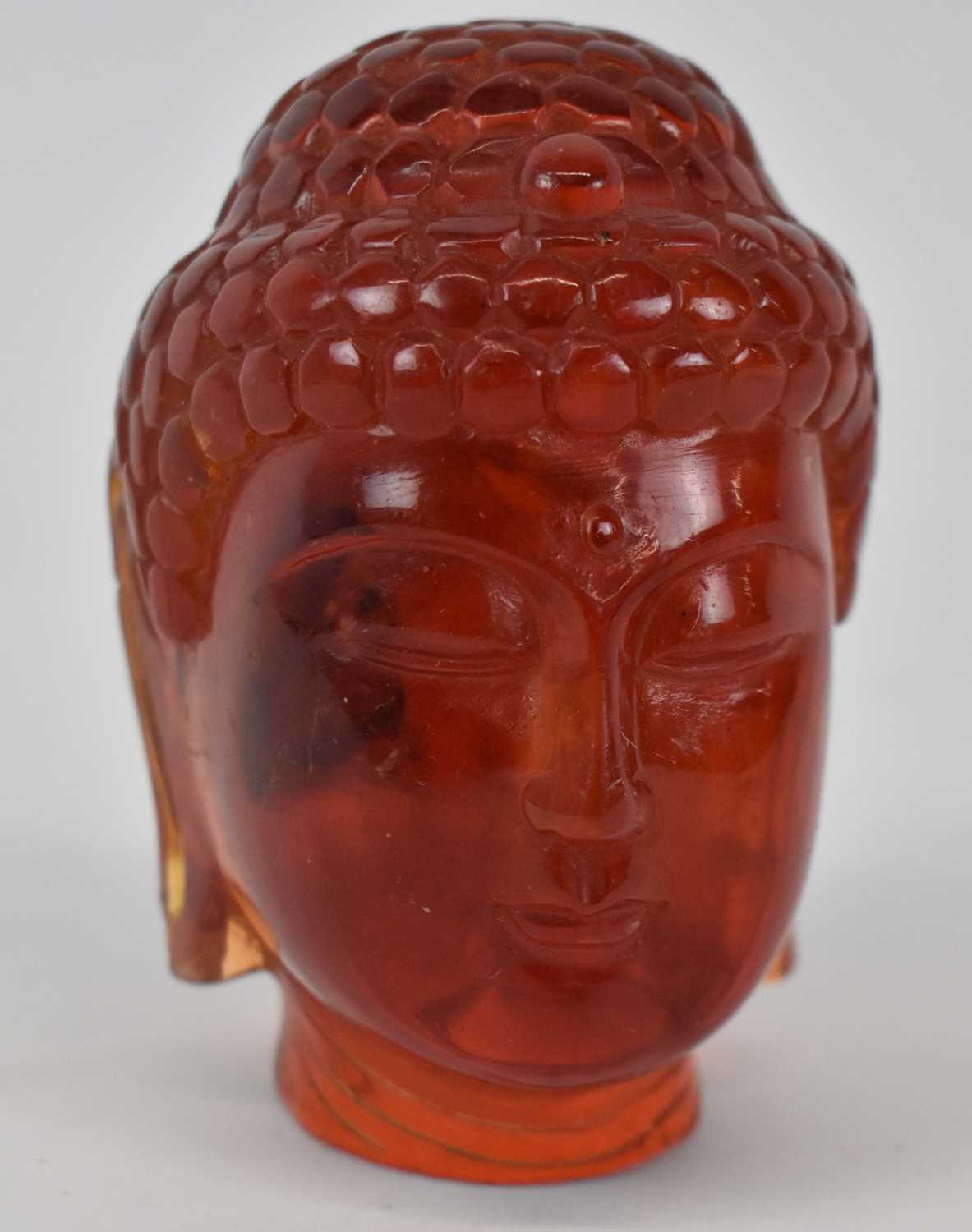 Lot 355 - A reconstituted amber Buddha head, height
