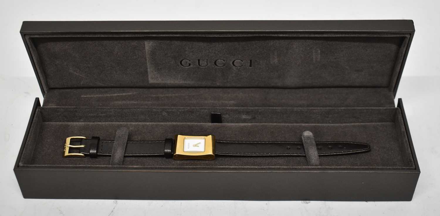 Lot 605 - GUCCI; a lady's gold tone cocktail watch