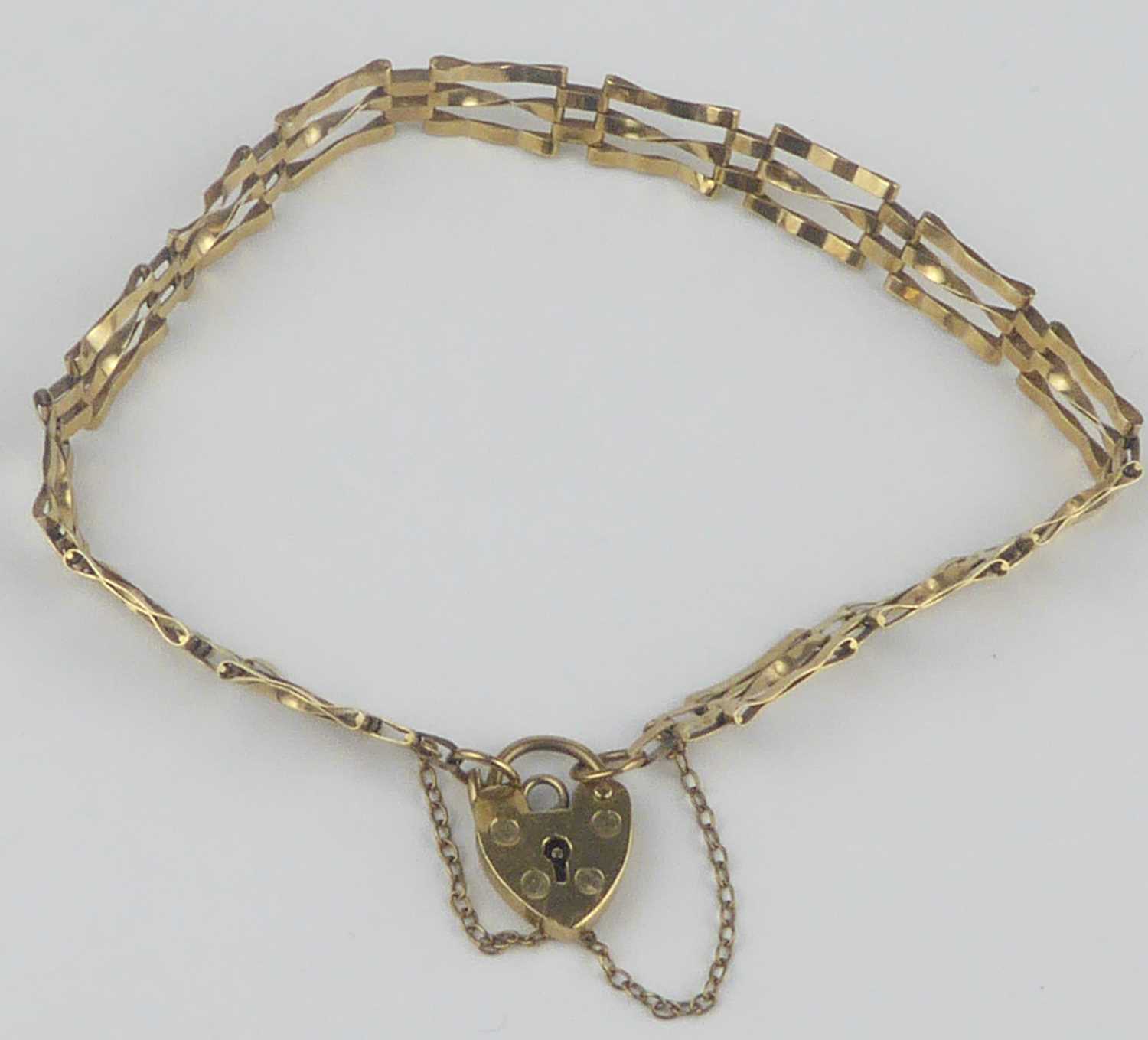 Lot 851 - A 9ct gold three bar dainty gate bracelet