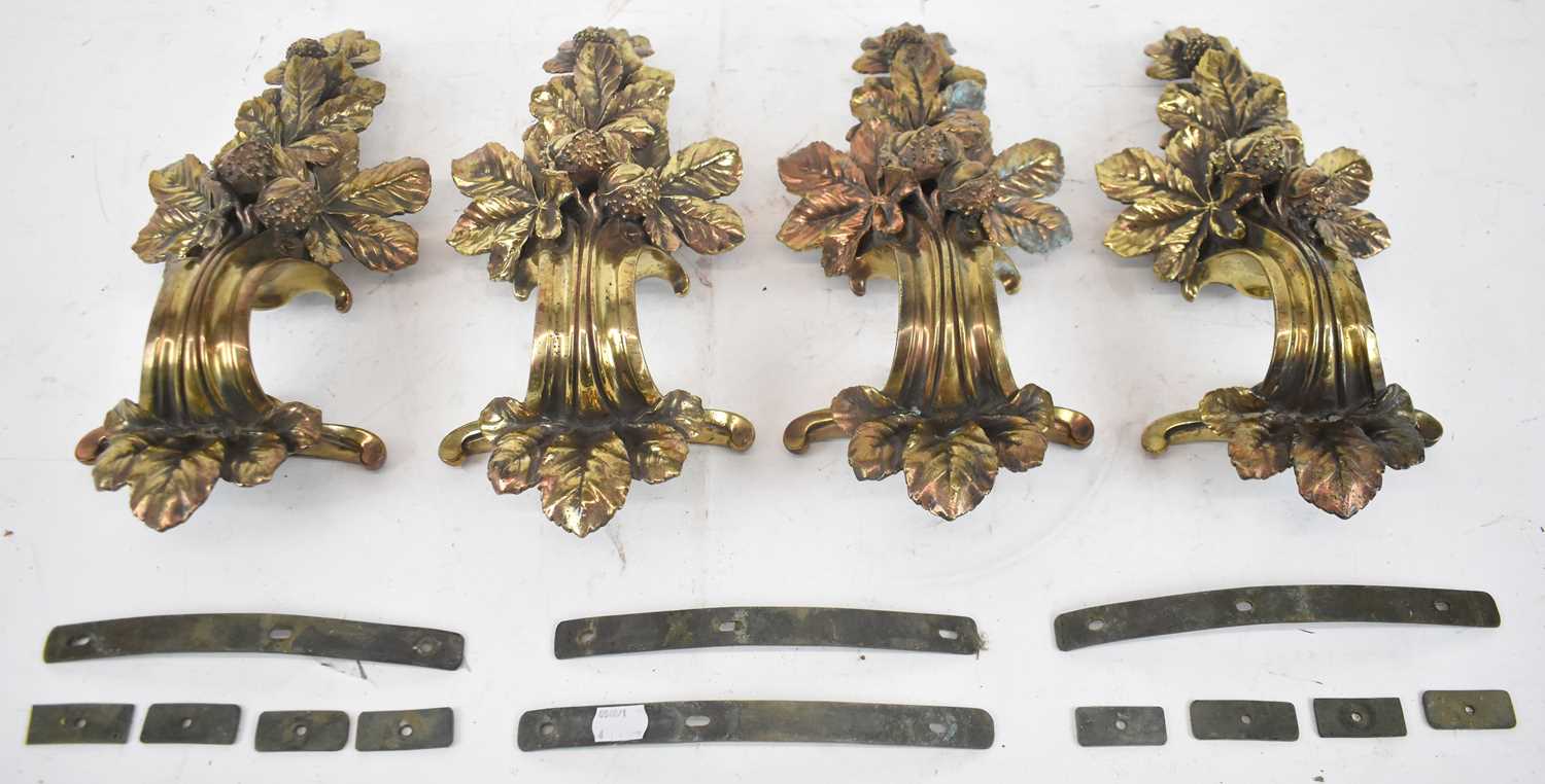 Lot 461 - A set of four heavy brass wall mounts, with