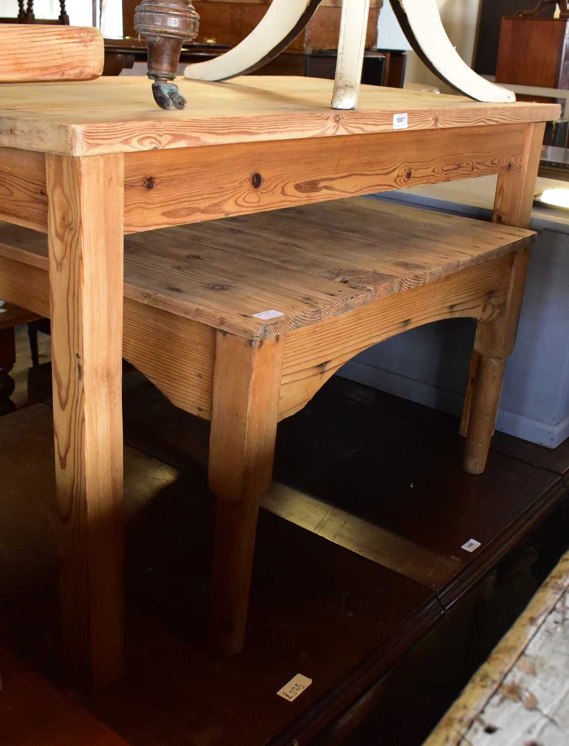 Lot 1097 - A pine rectangular dining table on block