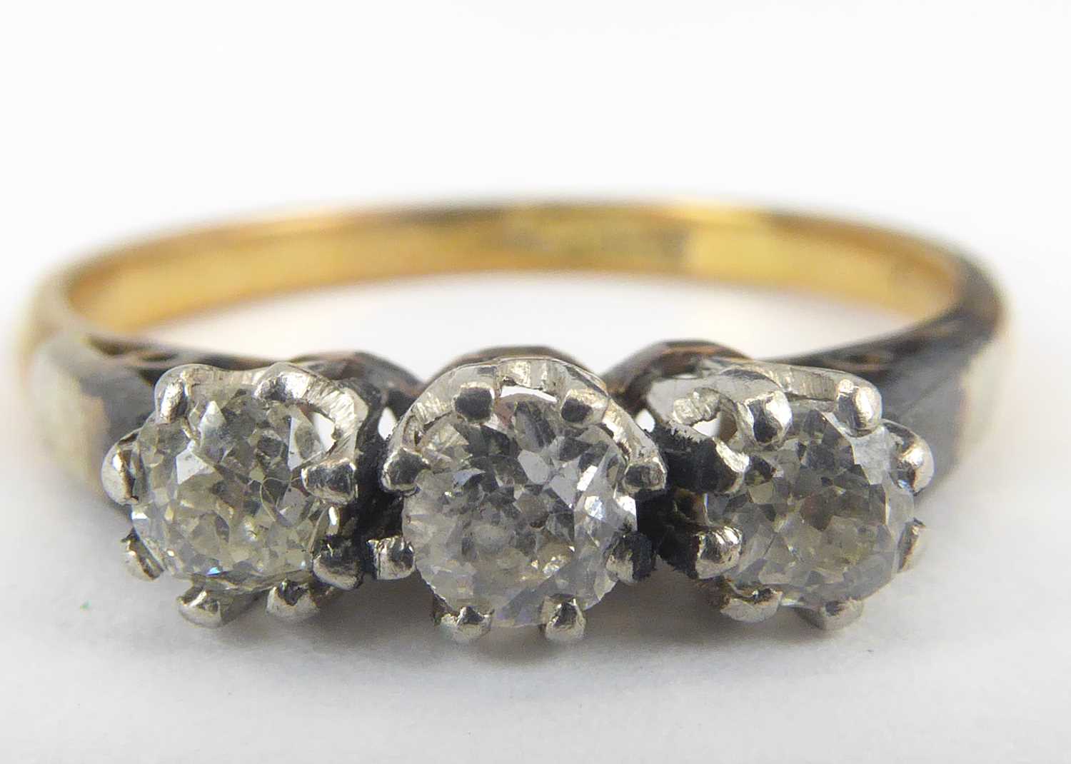 Lot 1004 - An 18ct gold three-stone diamond ring