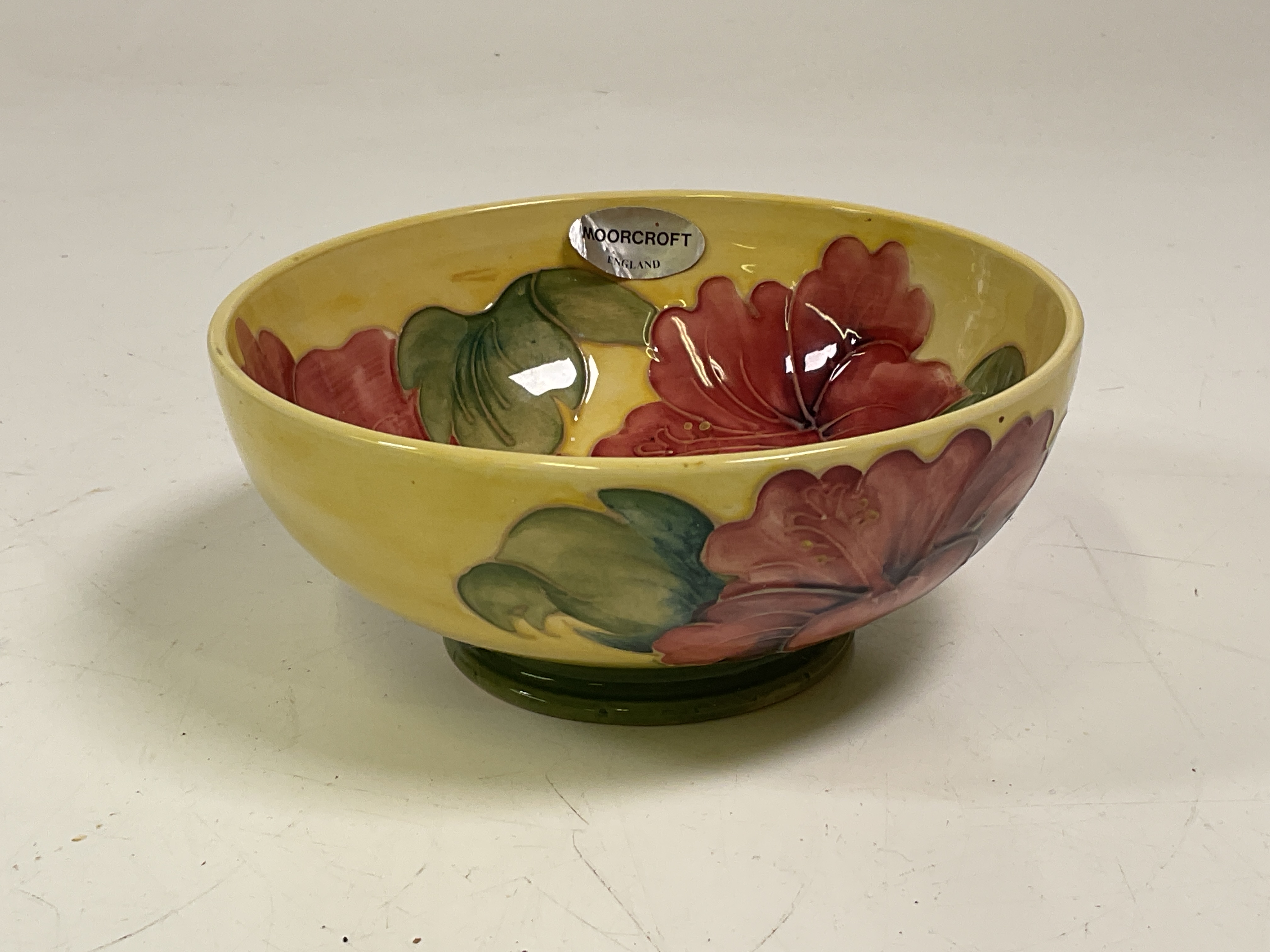 Lot 515 - MOORCROFT; a yellow ground pink 'Hibiscus'