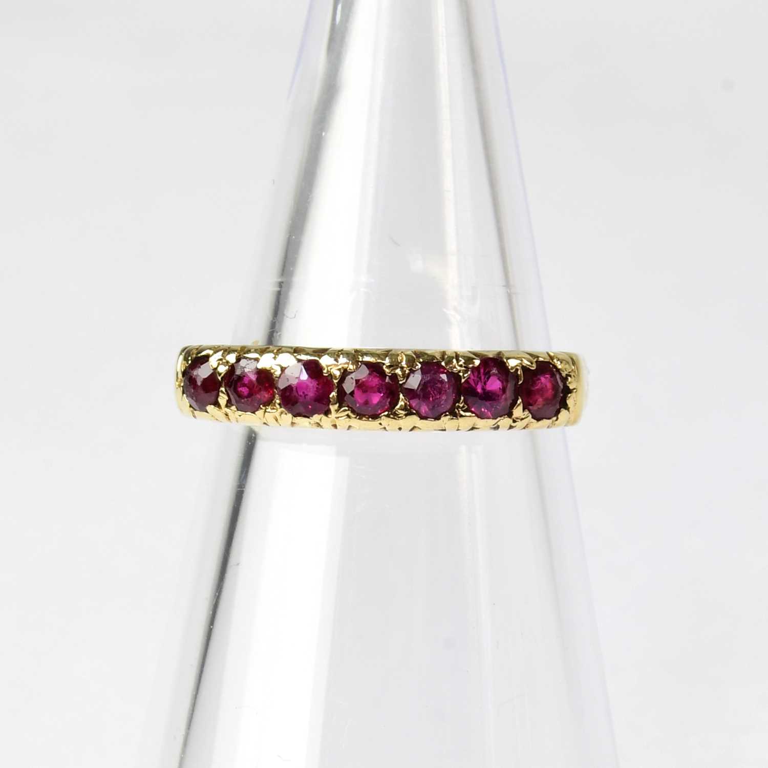 Lot 877 - A 9ct gold ruby set half eternity ring,