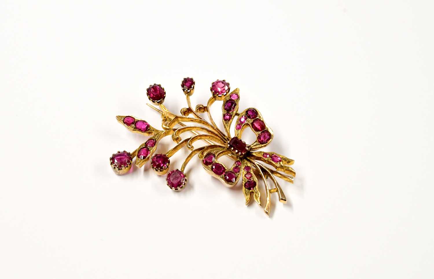 Lot 910 - A yellow metal open work brooch in the form