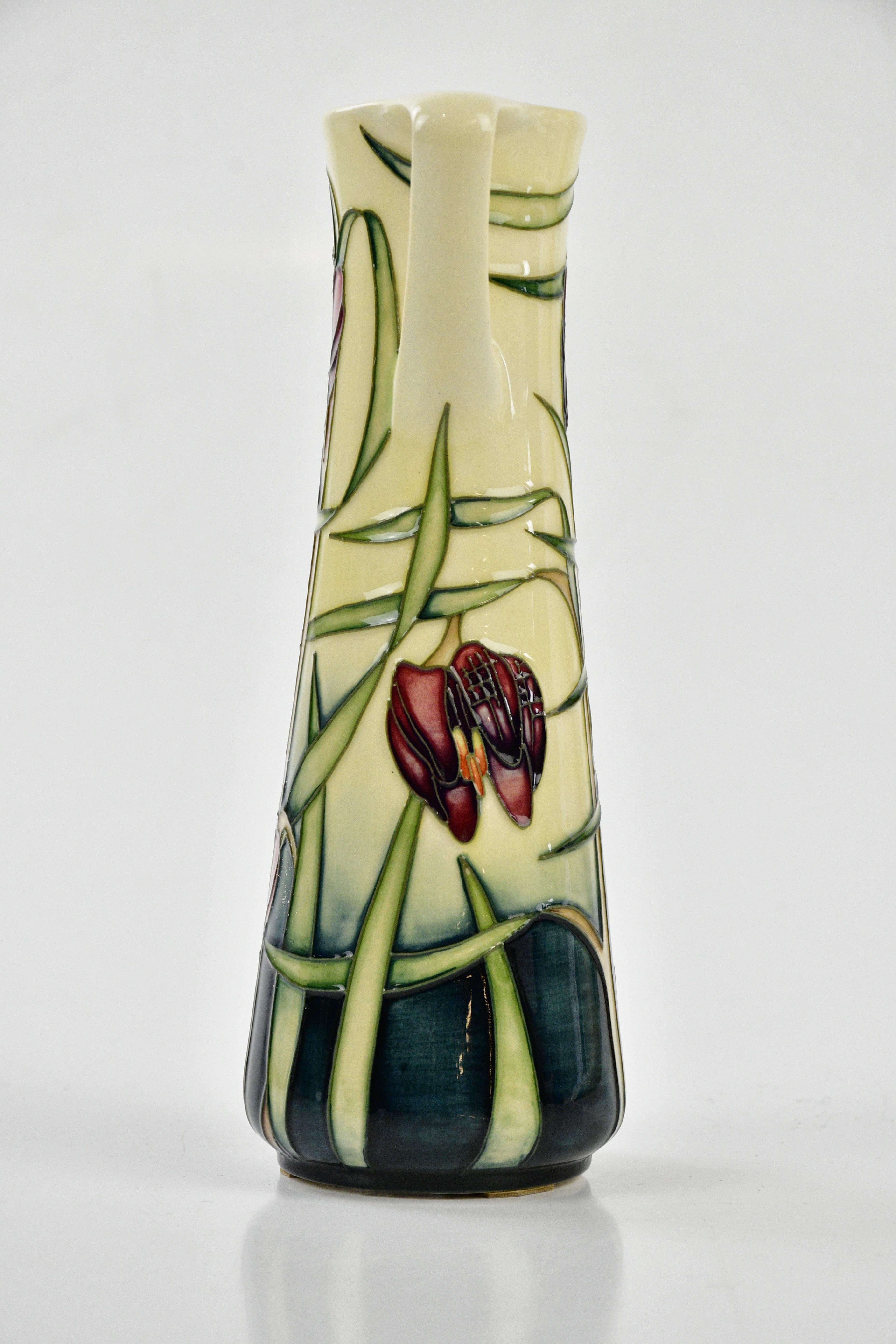 Lot 126 - EMMA BOSSONS FOR MOORCROFT; a ewer decorated