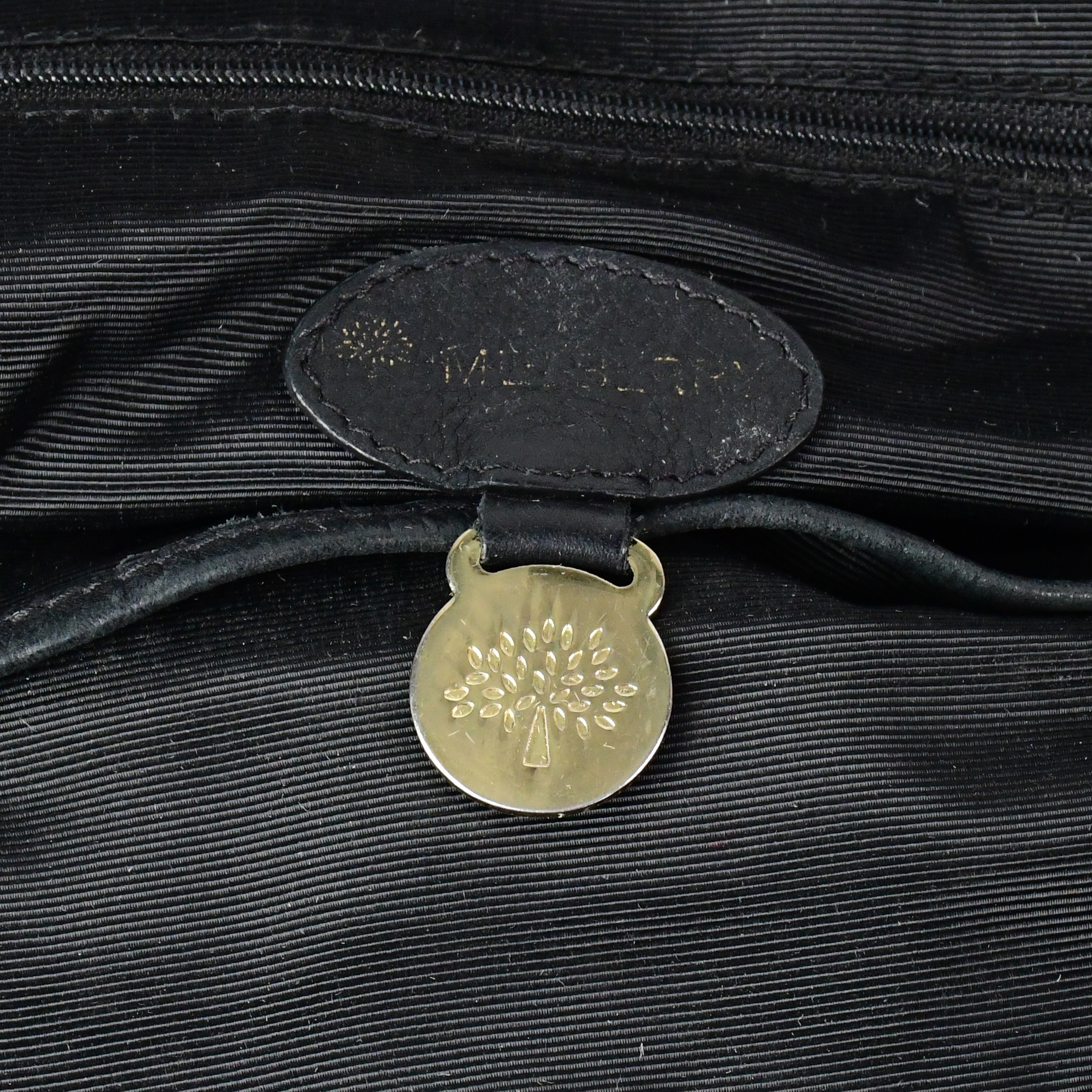 Lot 210 - MULBERRY; a black leather and brass handbag