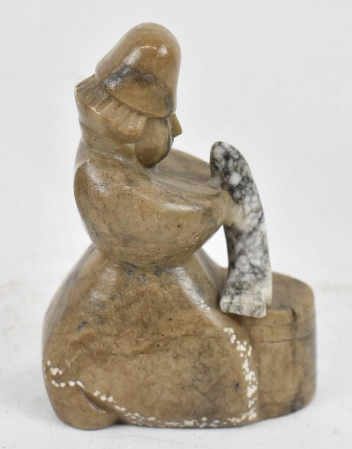 Lot 413 - A carved stone figure straddling a barrel