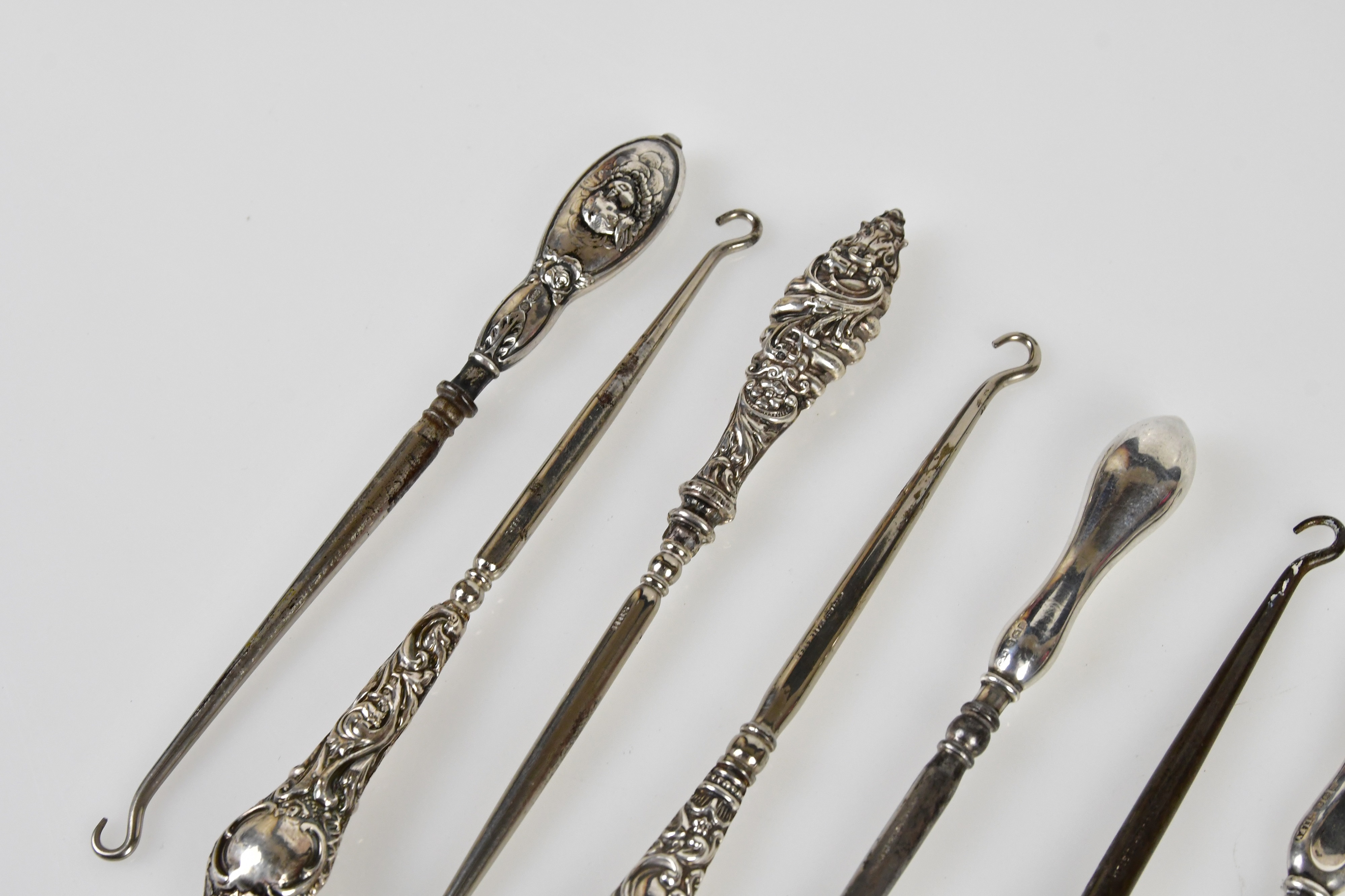 Lot 2492 - Nine hallmarked silver handled button hooks,