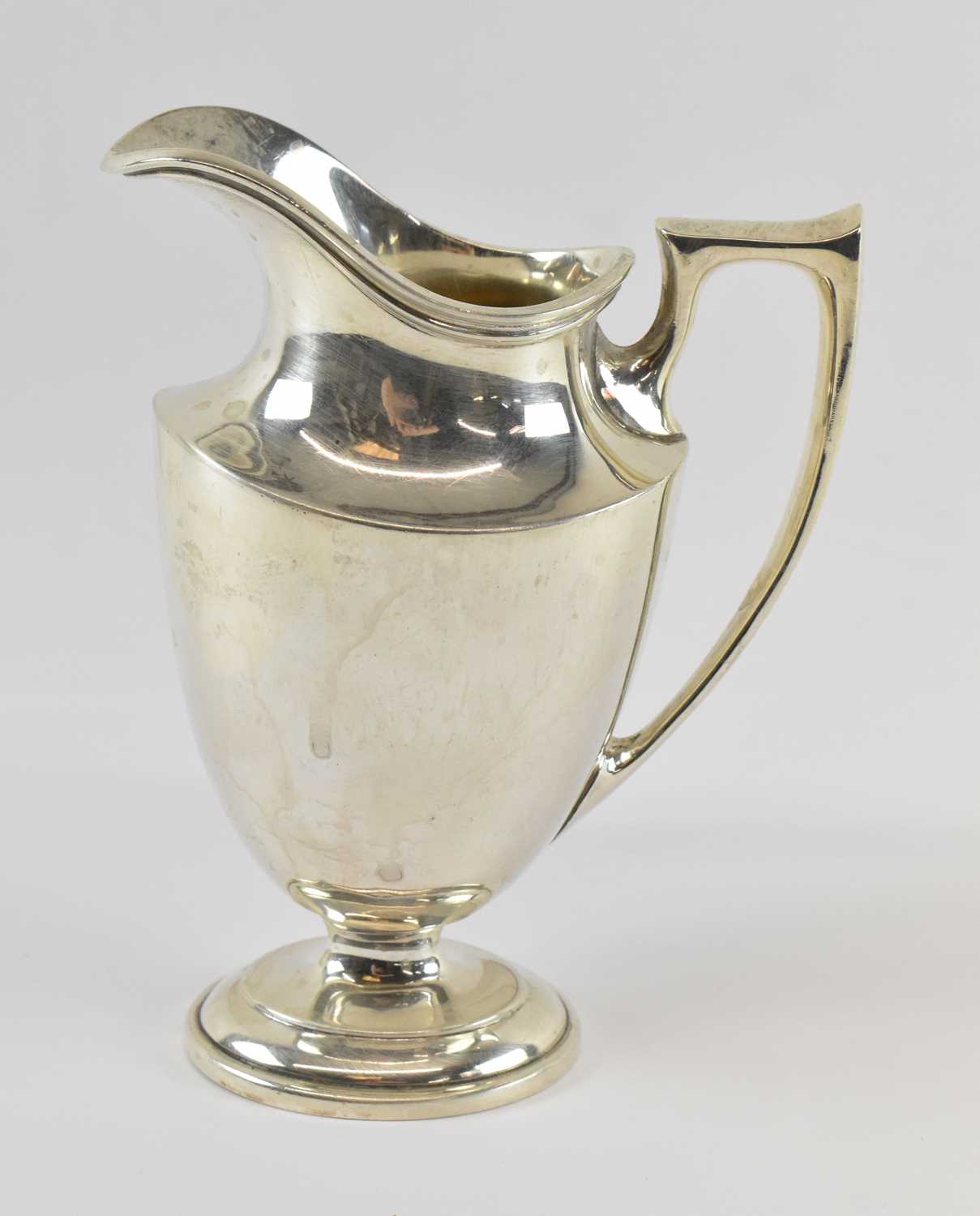 Lot 762 - A sterling silver cream jug, height 13cm,