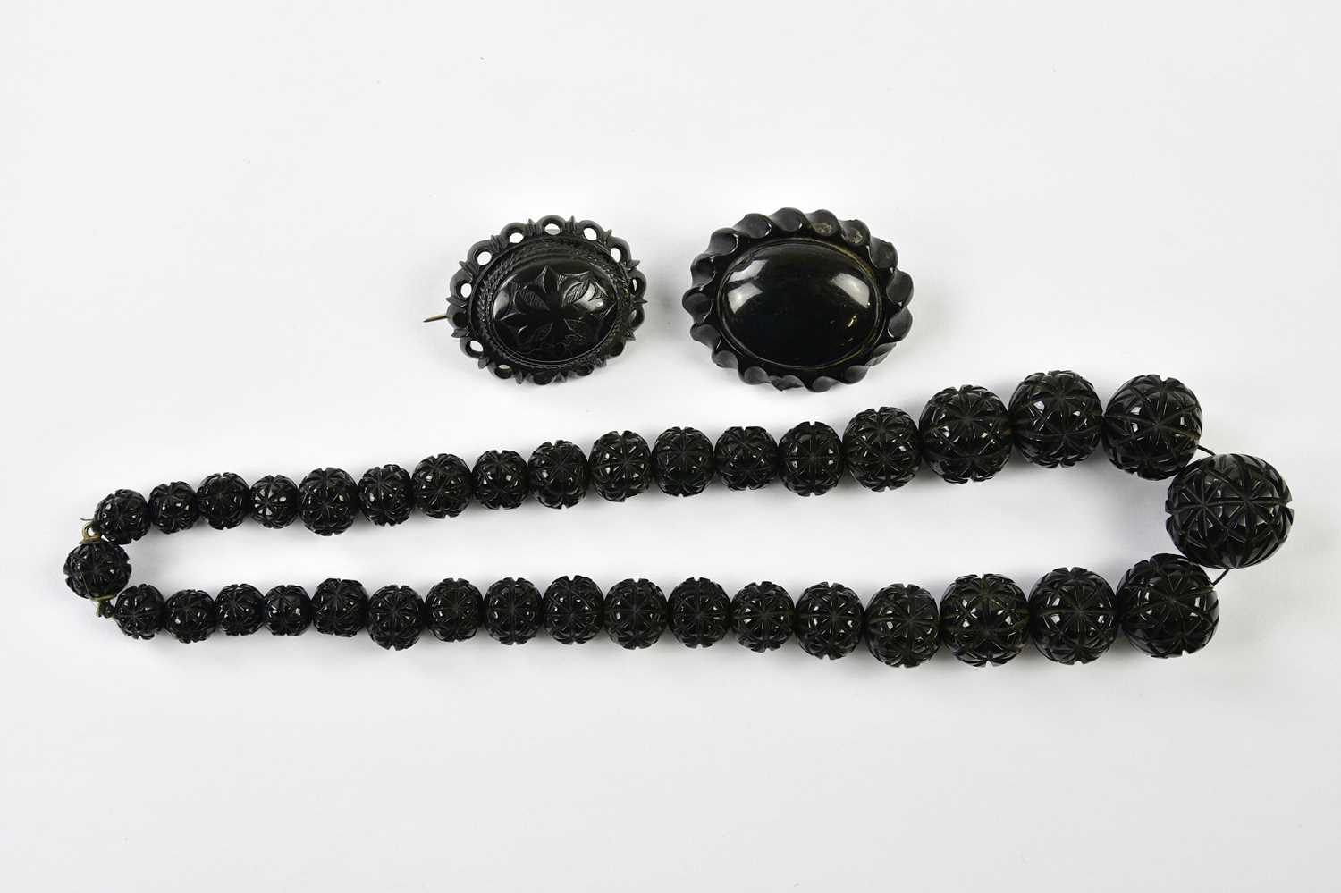 Lot 1154 - A 19th century carved jet necklace and two