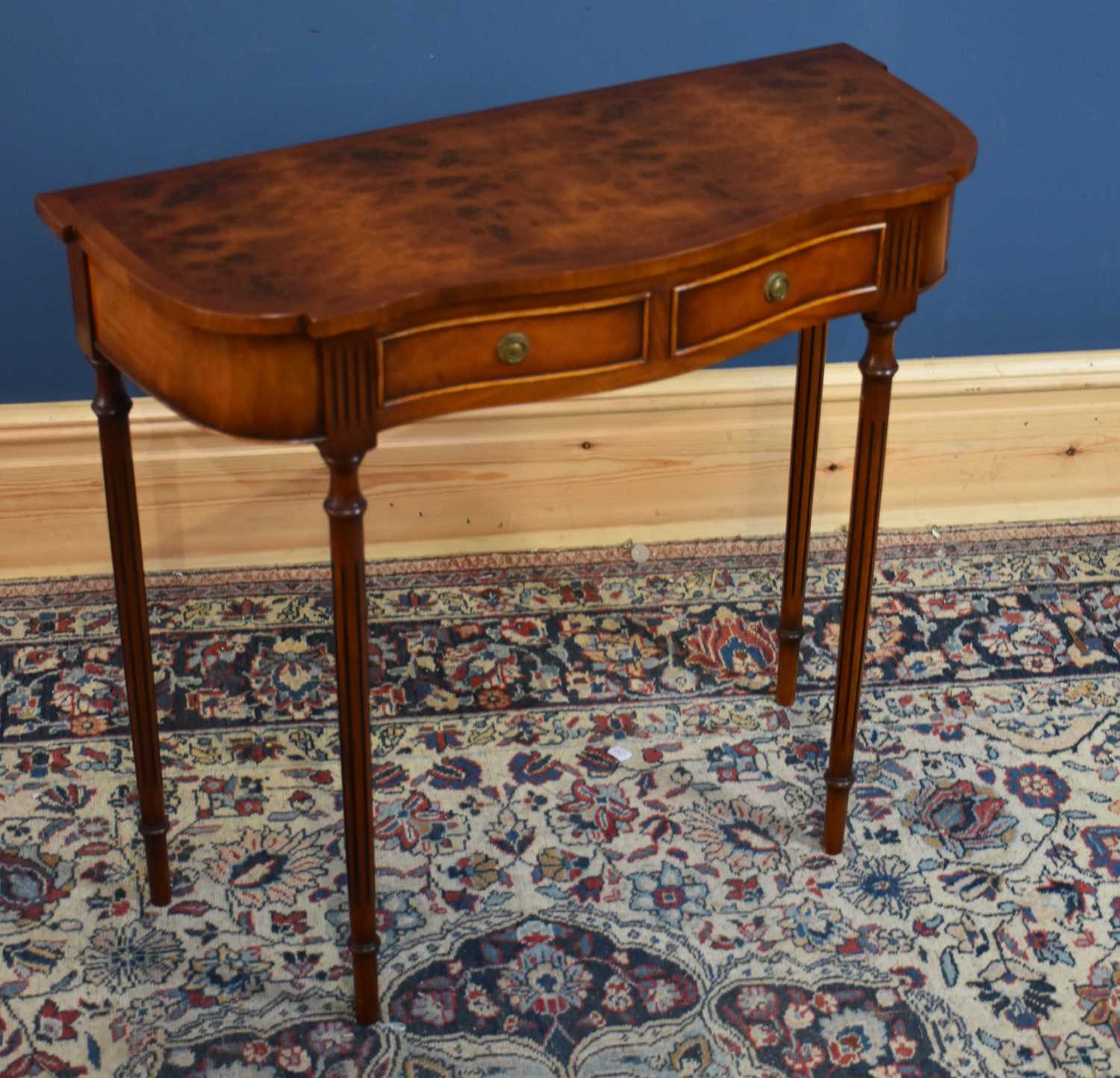 Lot 249 - A reproduction walnut two drawer hall table,