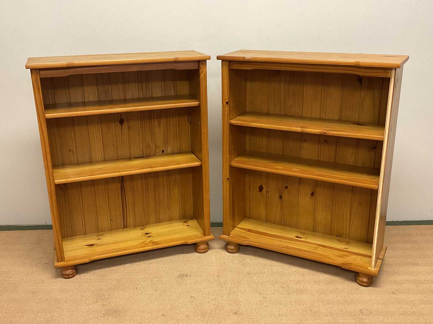 Lot 478 - A pair of pine bookcases, height 106cm,