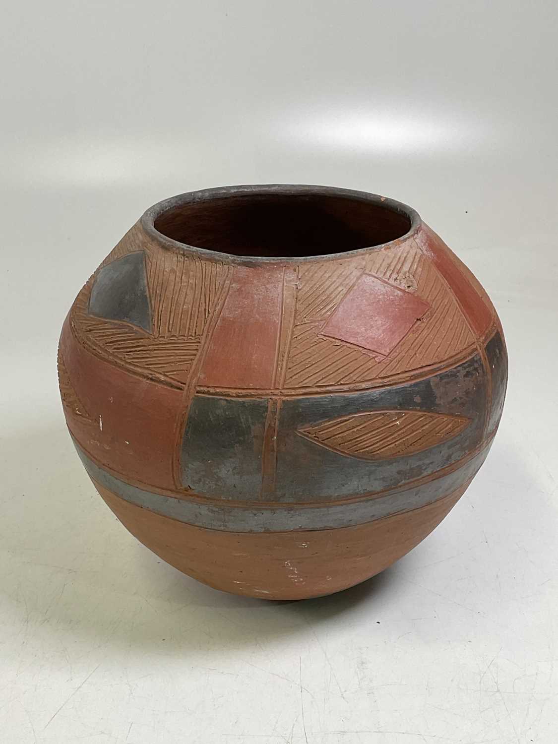 Lot 201 - An African painted terracotta globular pot