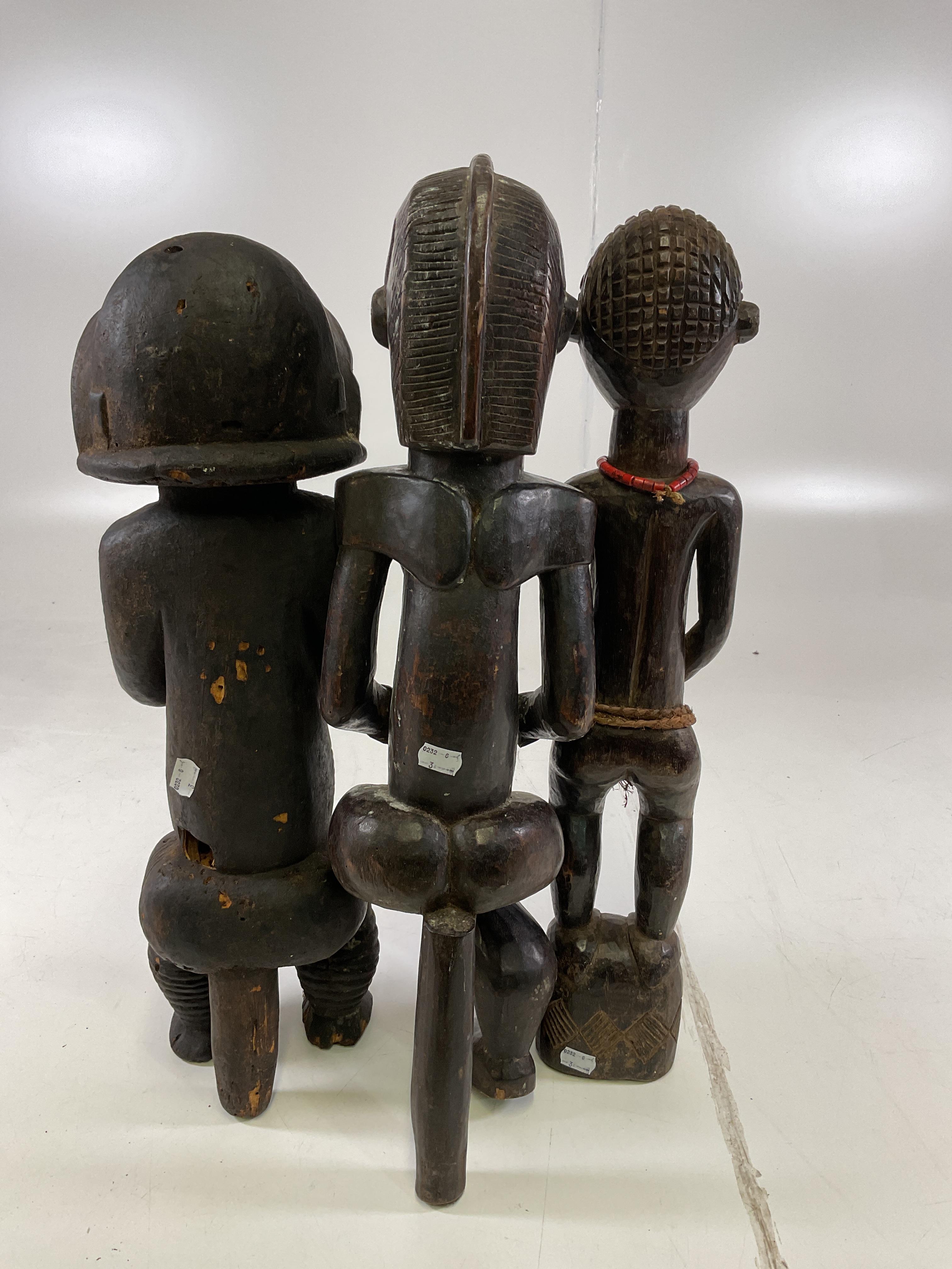 Lot 75 - Three African carved wooden tribal figures,