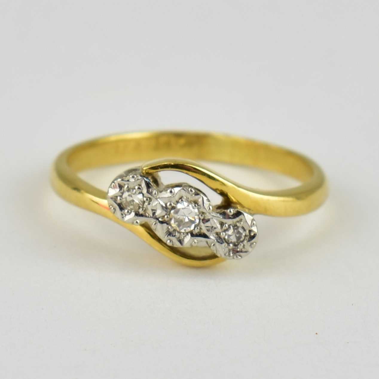 Lot 767 - A 9ct gold three-stone illusion set diamond