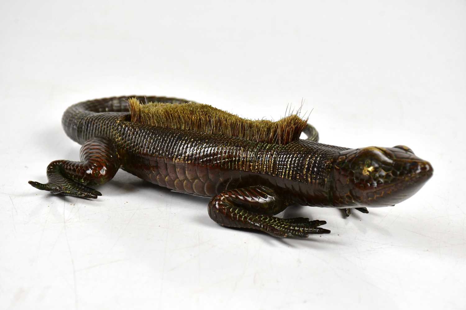 Lot 1103 - A 19th century bronze pen wiper in the form