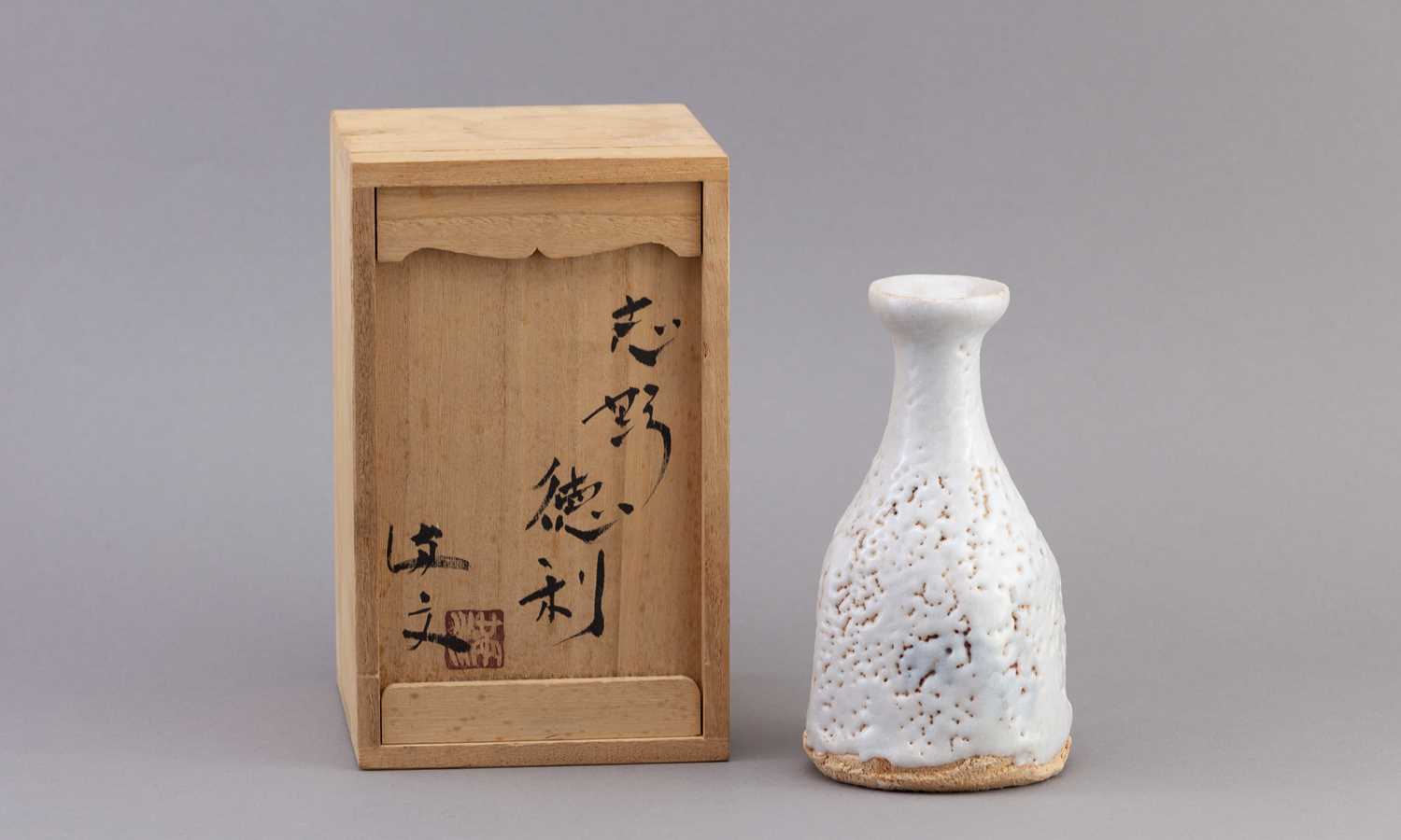 Lot 621 - A Japanese stoneware tokkuri covered in