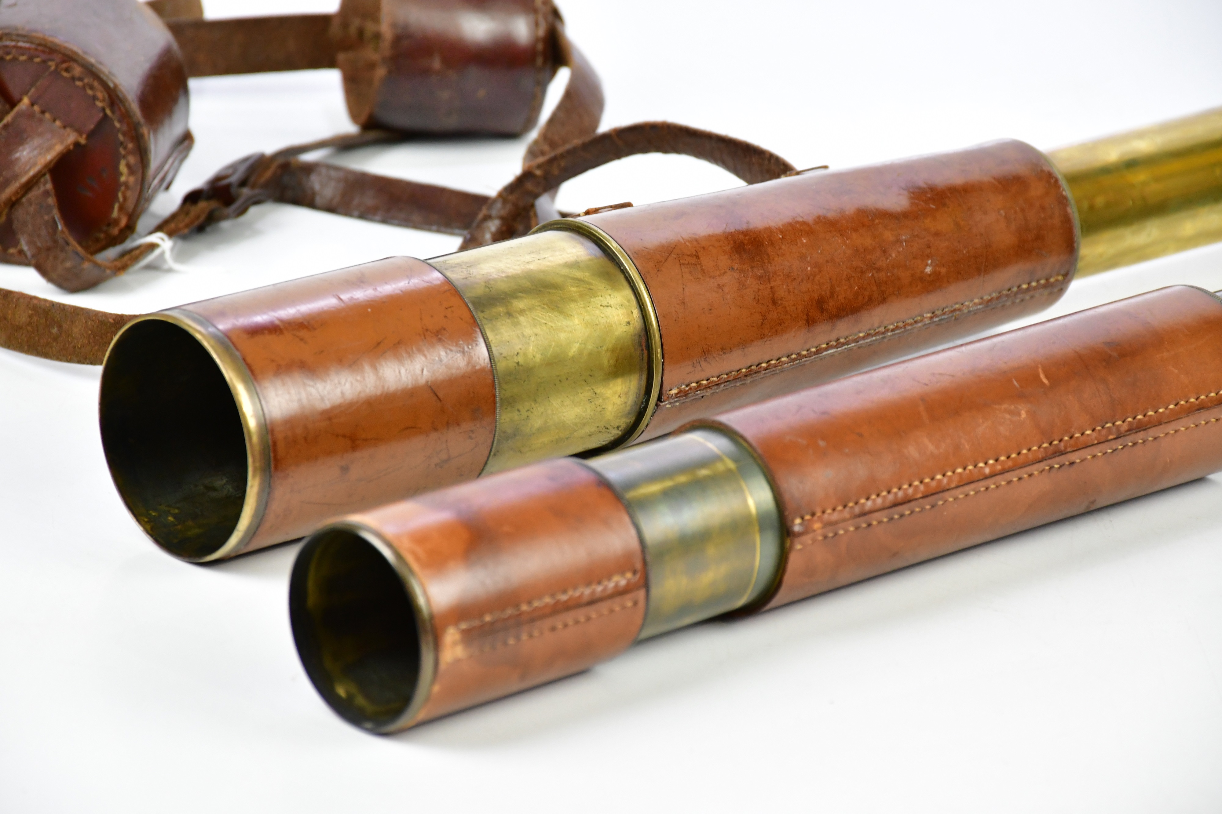 Lot 2167 - Two leather mounted telescopes including a