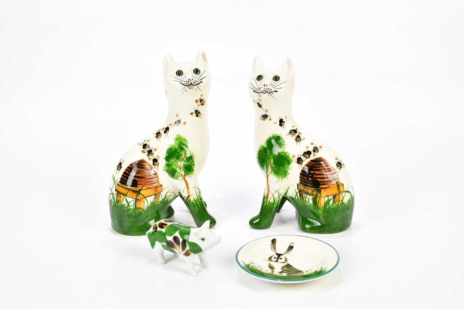 Lot 1446 - G HILL POTTERY; a pair of seated cats,