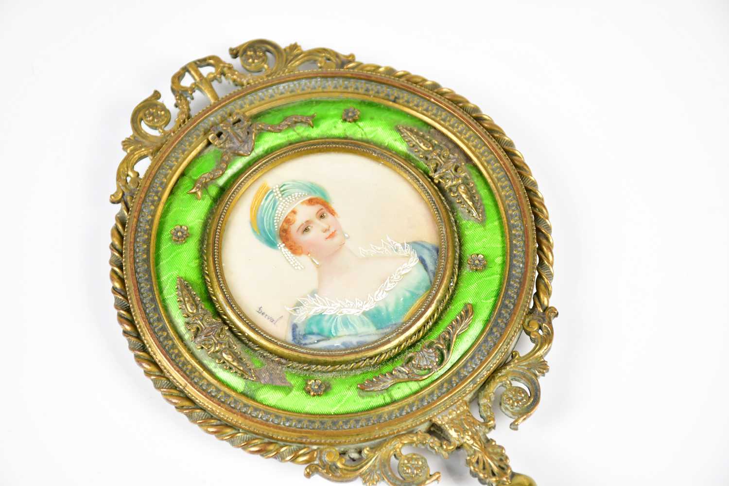 Lot 1128 - A gilt metal decorative hand mirror with