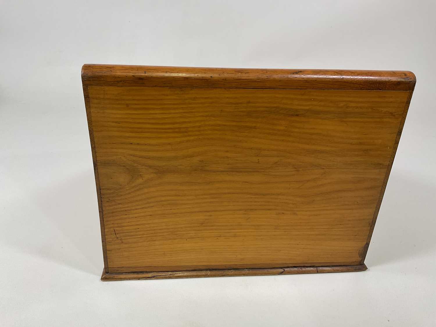 Lot 18 - A tambour front light oak desk tidy with