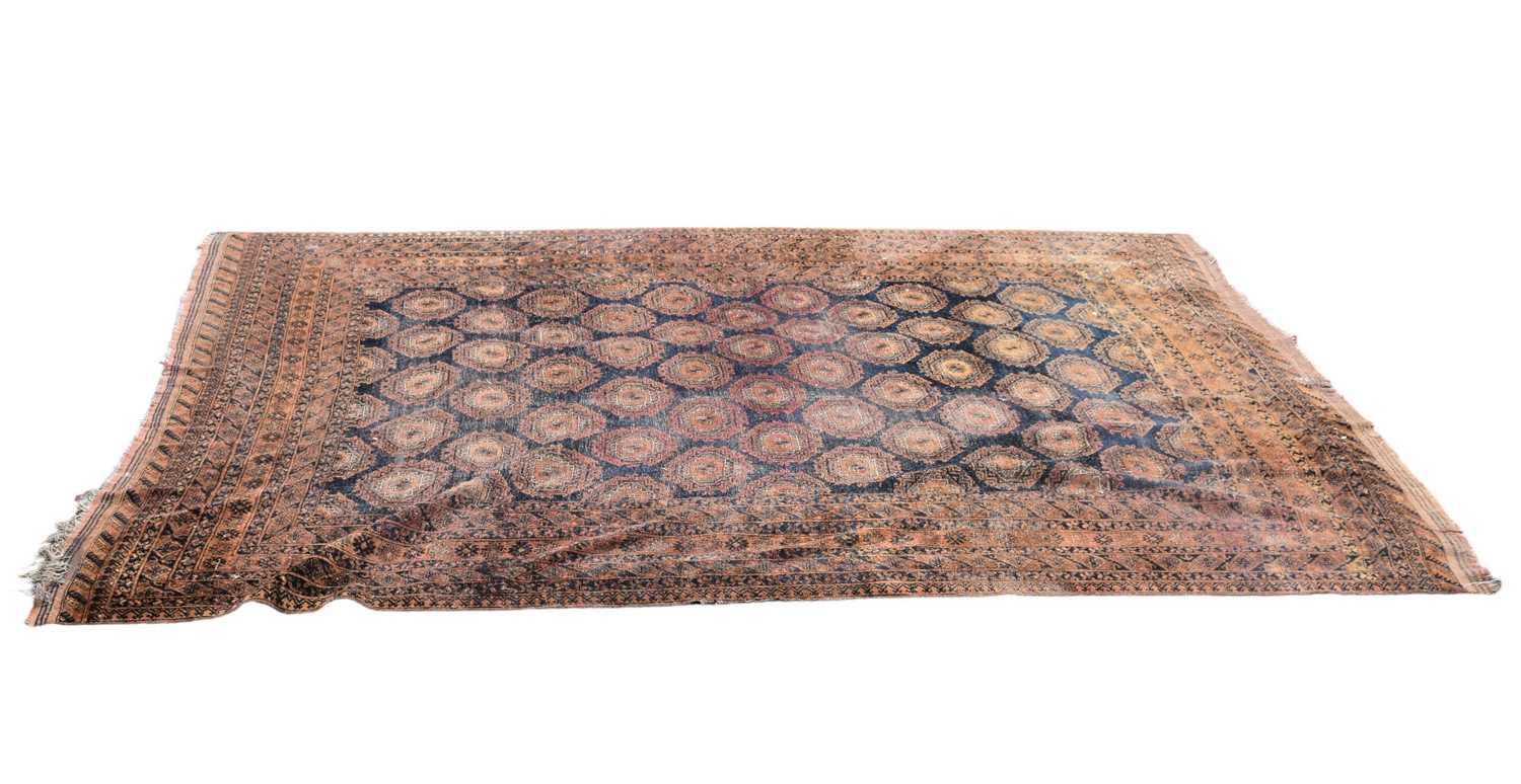 Lot 336 - An Eastern style rust ground carpet, with