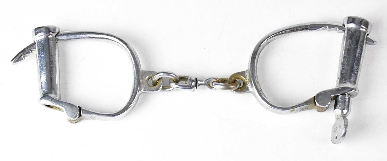 Lot 576 - A pair of vintage chrome plated handcuffs