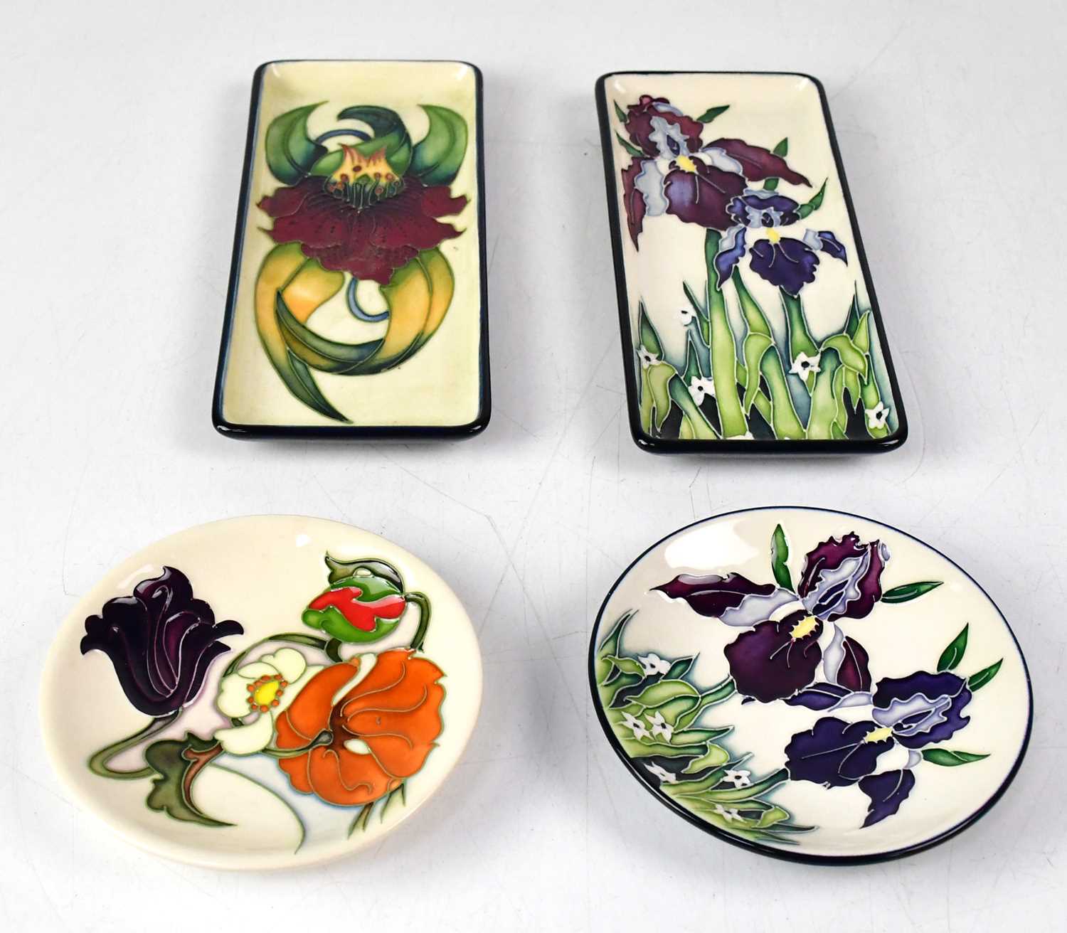 Lot 353 - MOORCROFT; a cream ground pen tray with