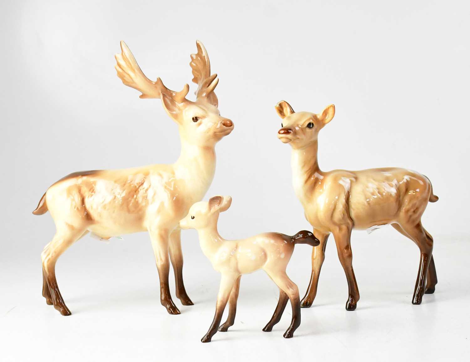 Lot 381 - BESWICK; a family of three deer figures,