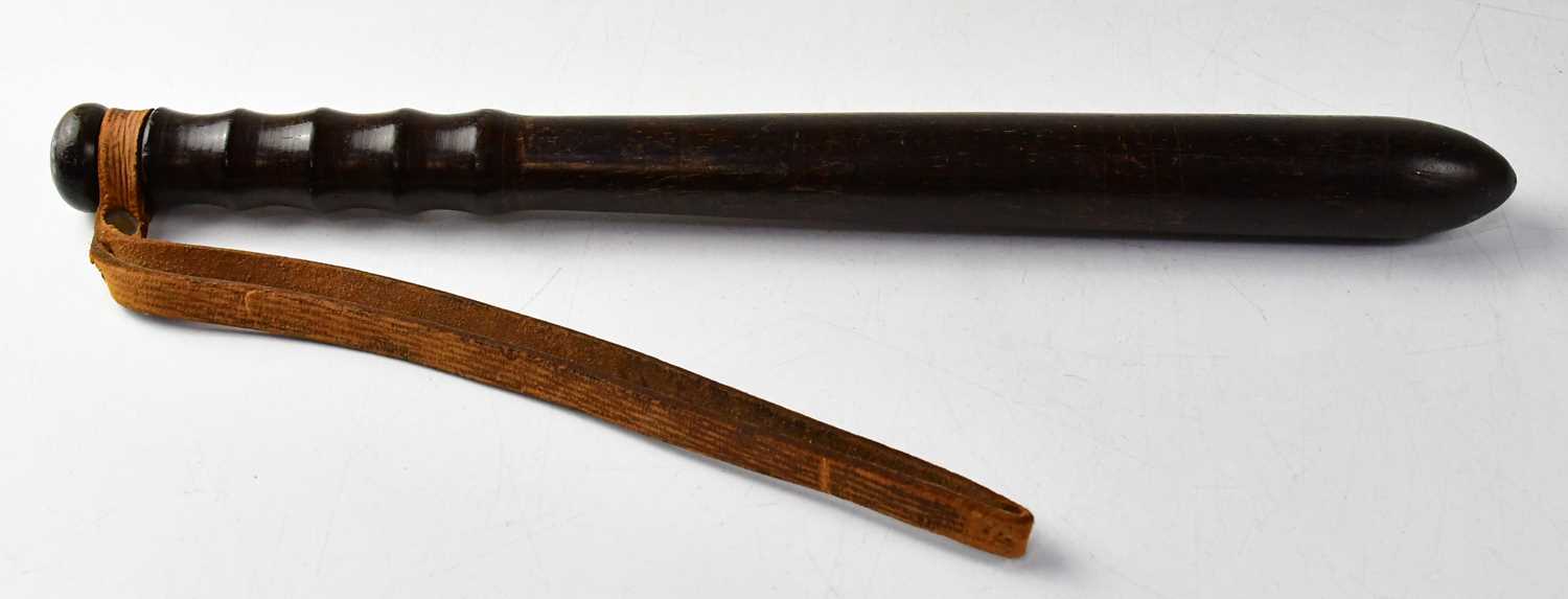 Lot 418 - A turned wooden military truncheon, marked