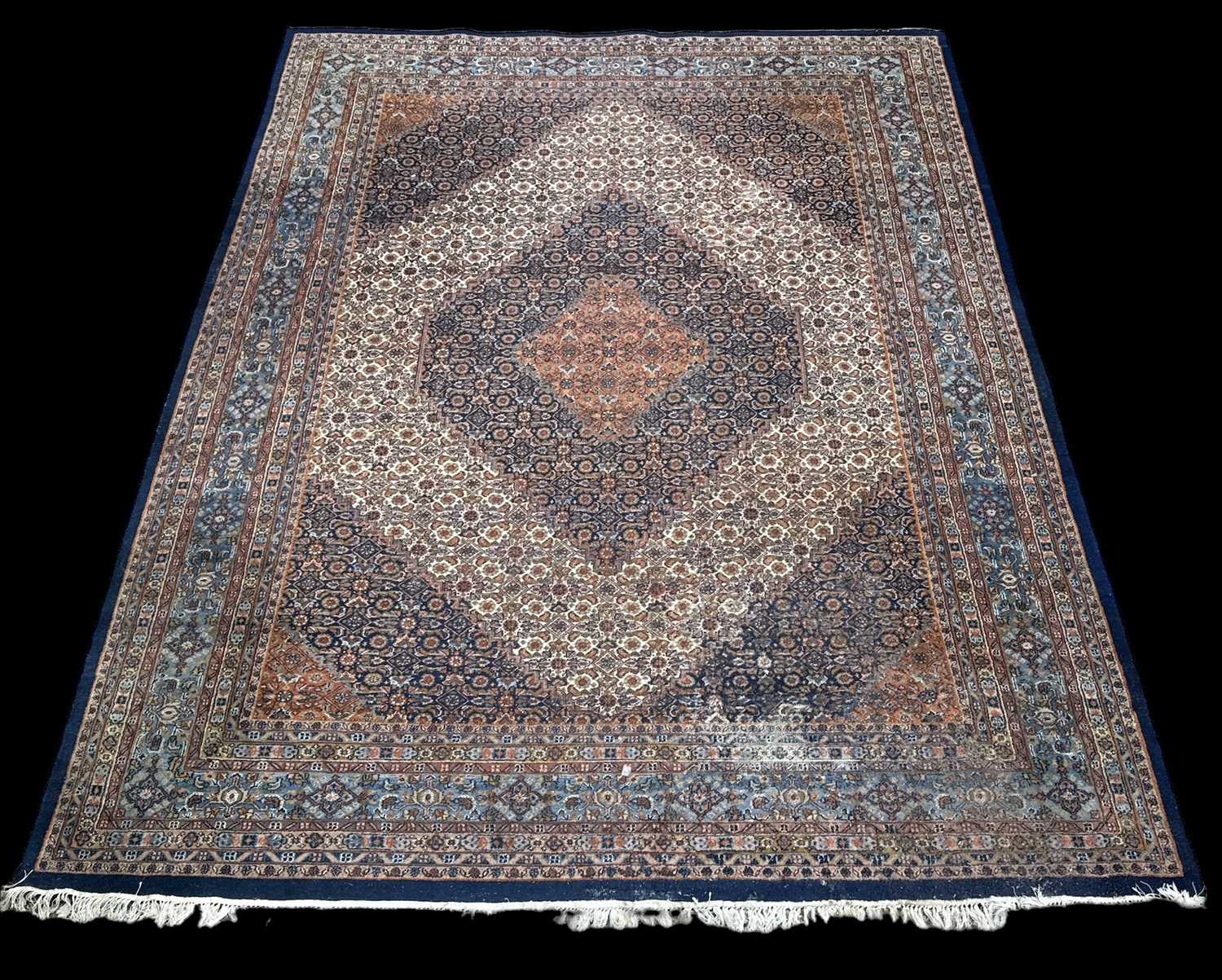 Lot 127 - A large Persian rug with geometric design,