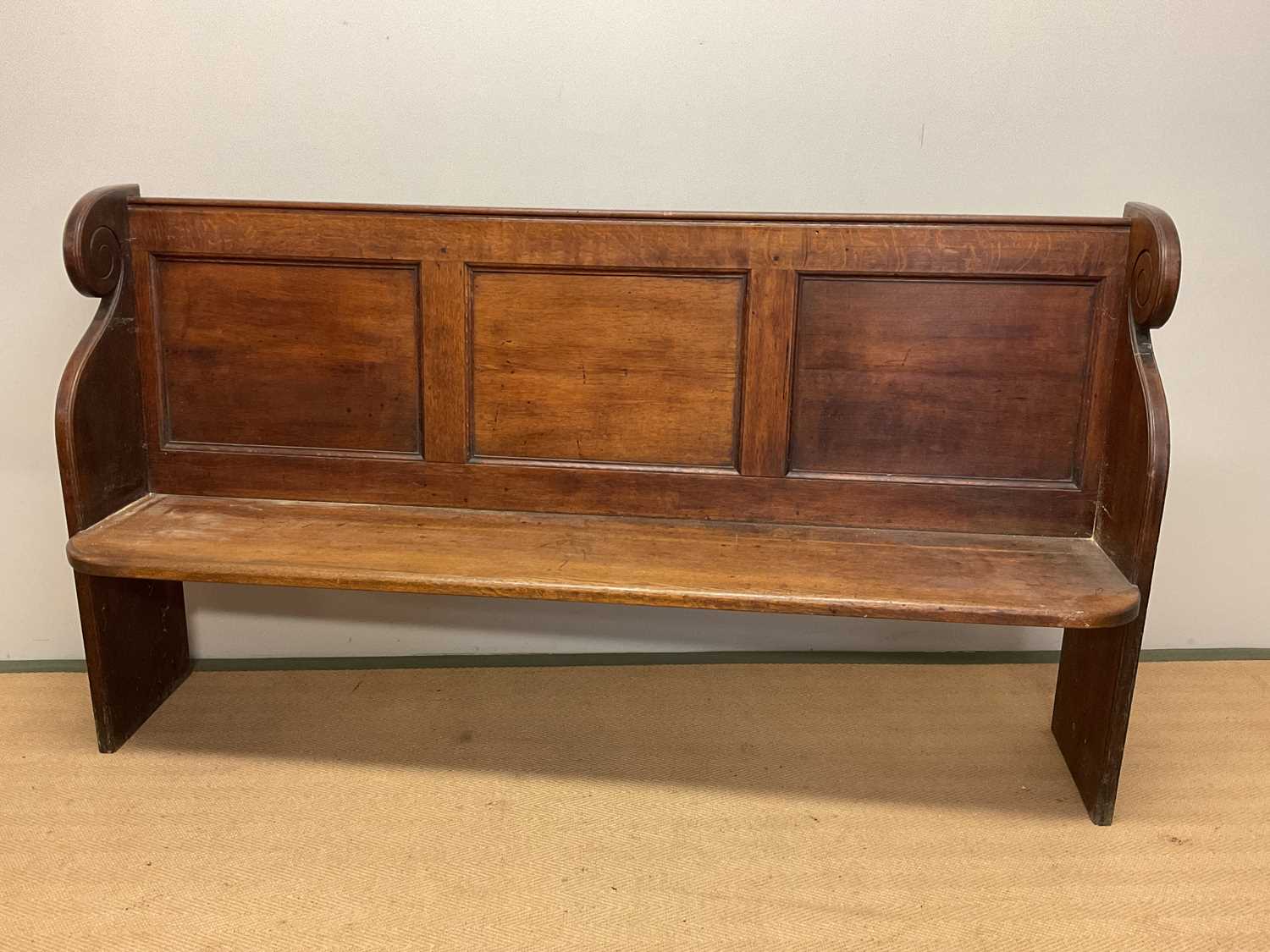 Lot 643 - A 19th century oak panelled back church pew