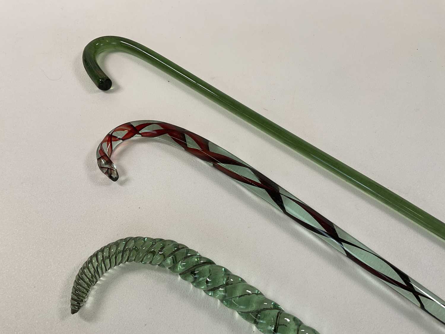 Lot 124 - Three Victorian Nailsea glass walking canes,