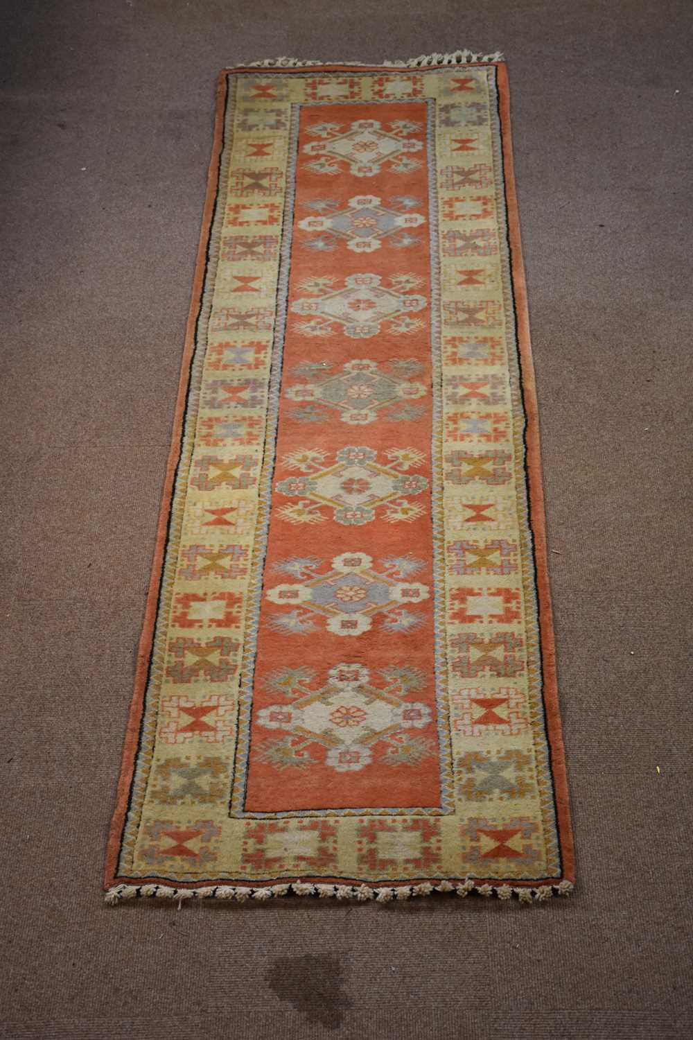 Lot 1214 - A hand woven wool runner, worked with a