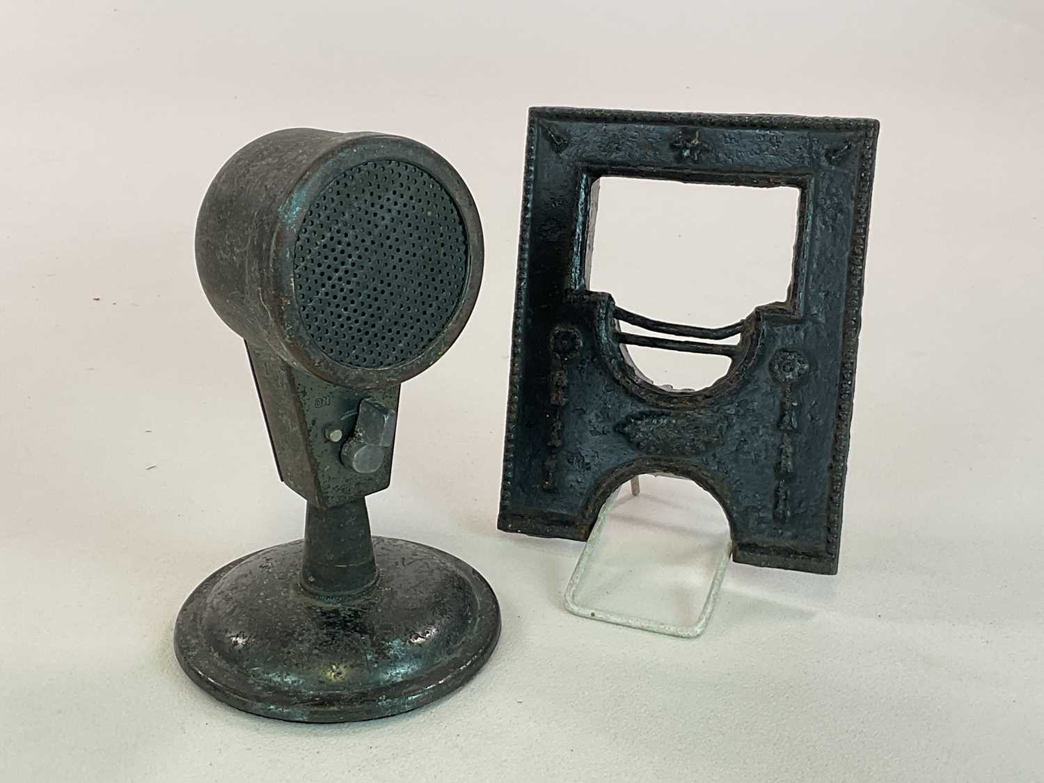 Lot 135 - An iron tabletop microphone with bakelite